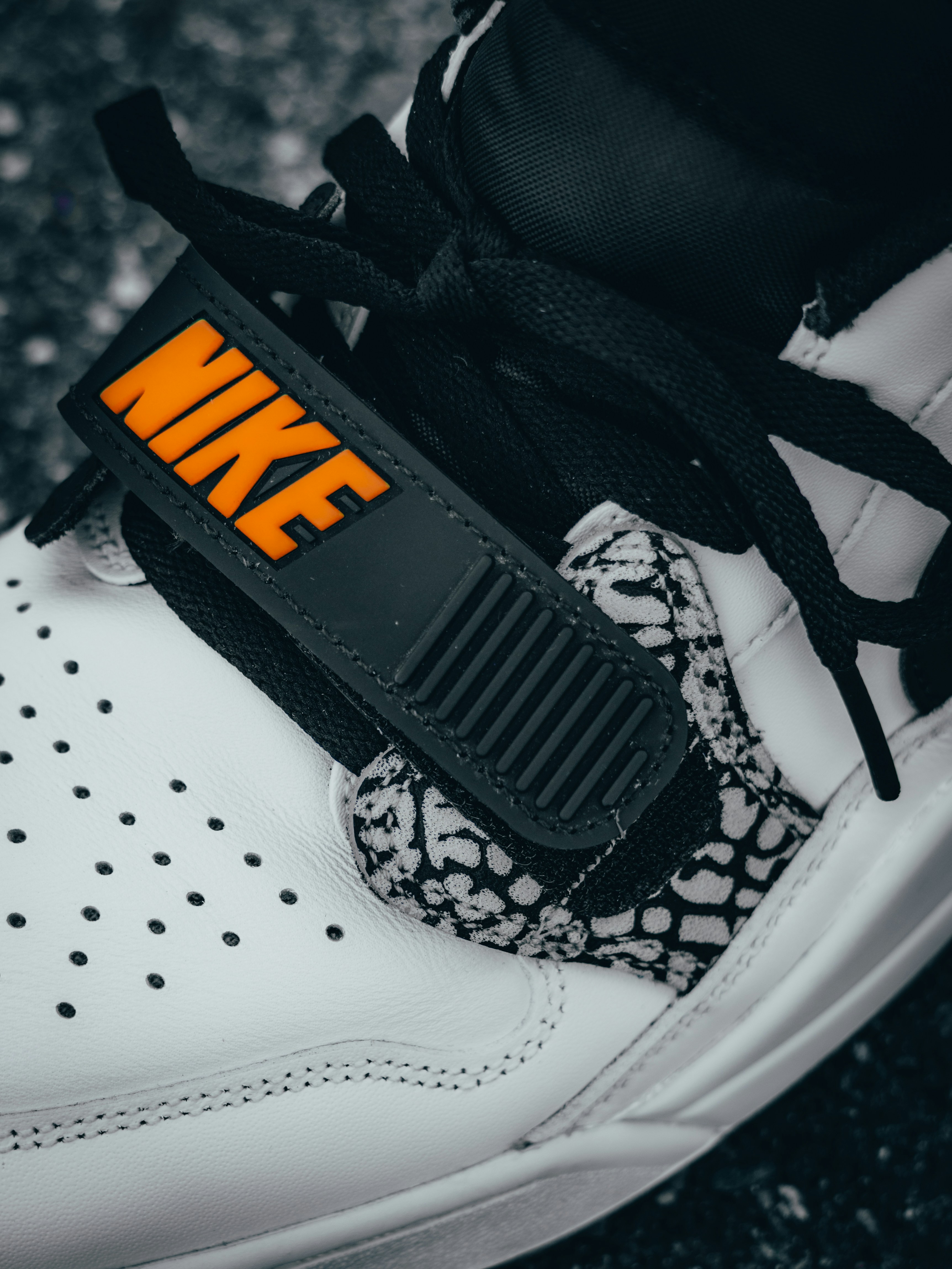 Orangey Zip: The Nike Strap on White Sneaker Close-up