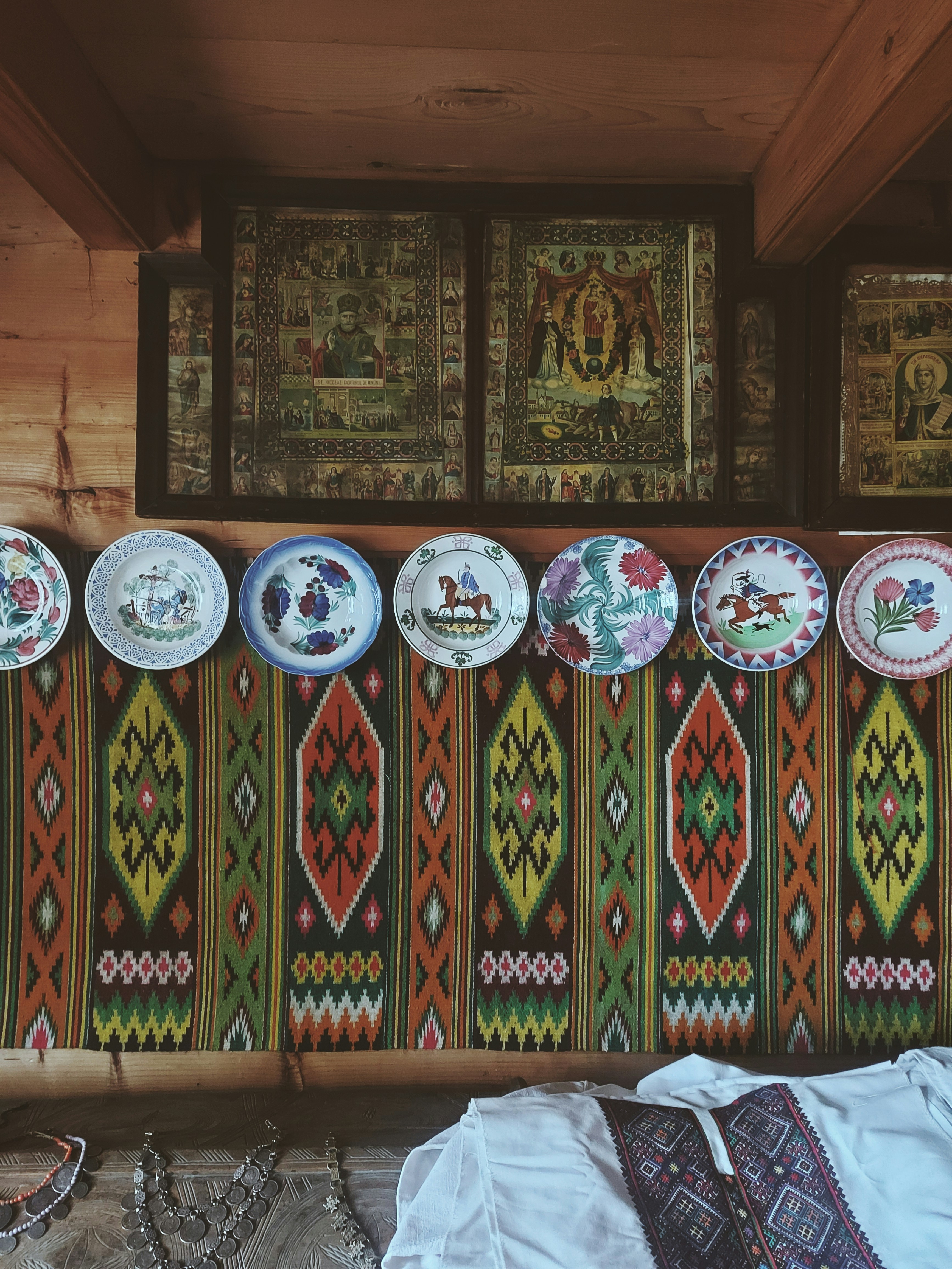 Heritage Display: Painted Plates Framed by Textile Wall Rug