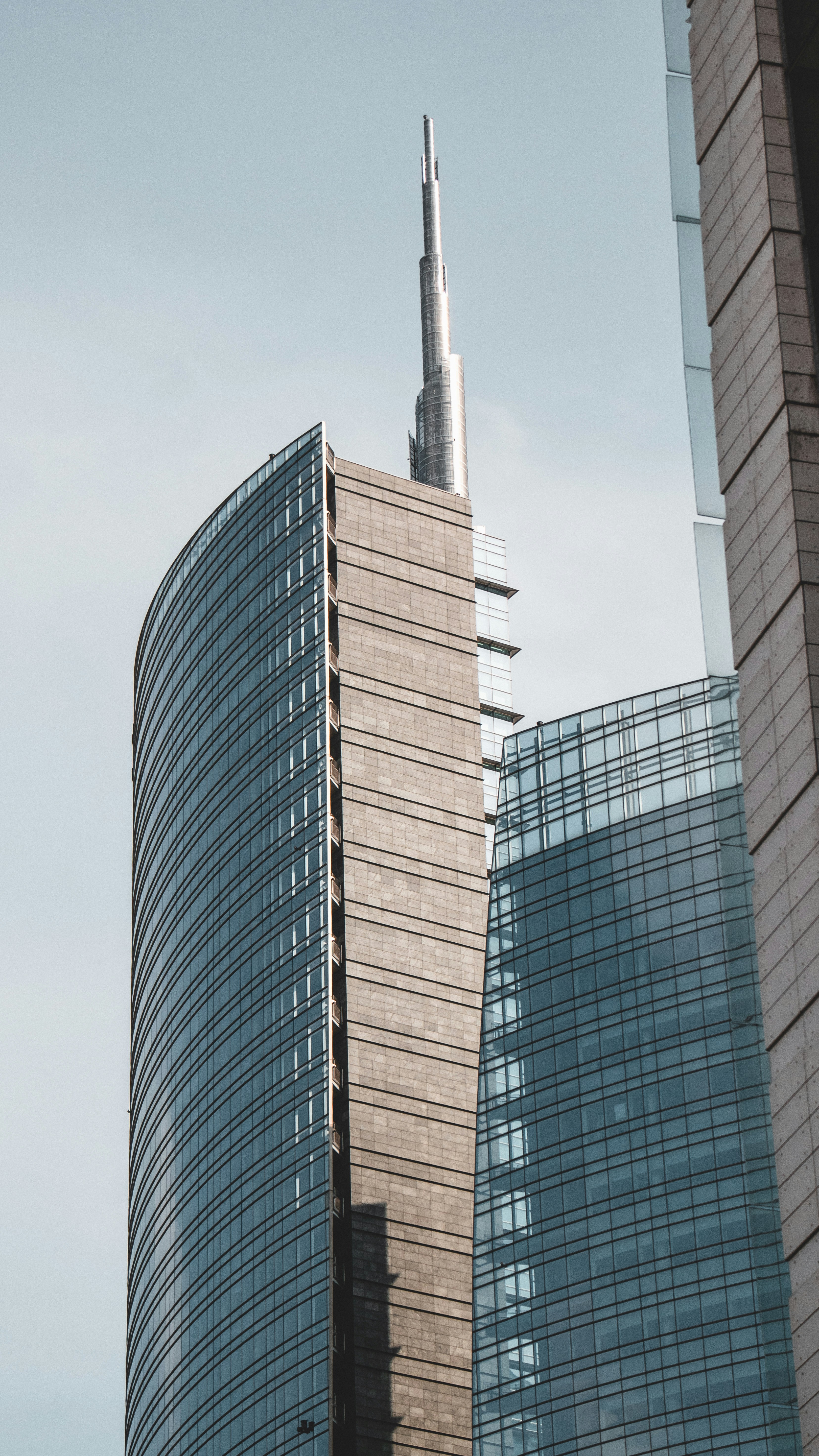 A tall building with a spire on top of it photo – Free Metropolitan ...