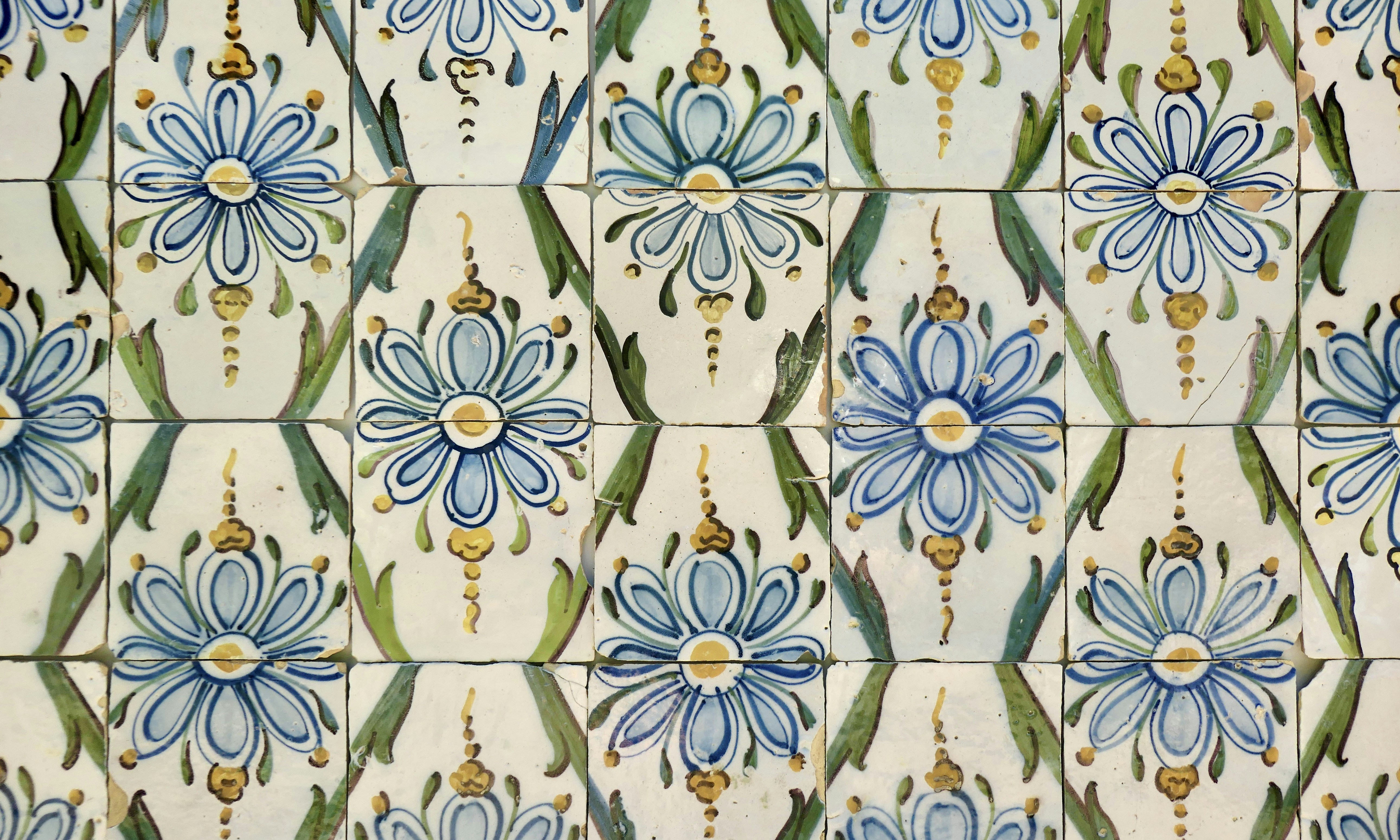 Decorative ceramic tiles with blue floral patterns and green accents.