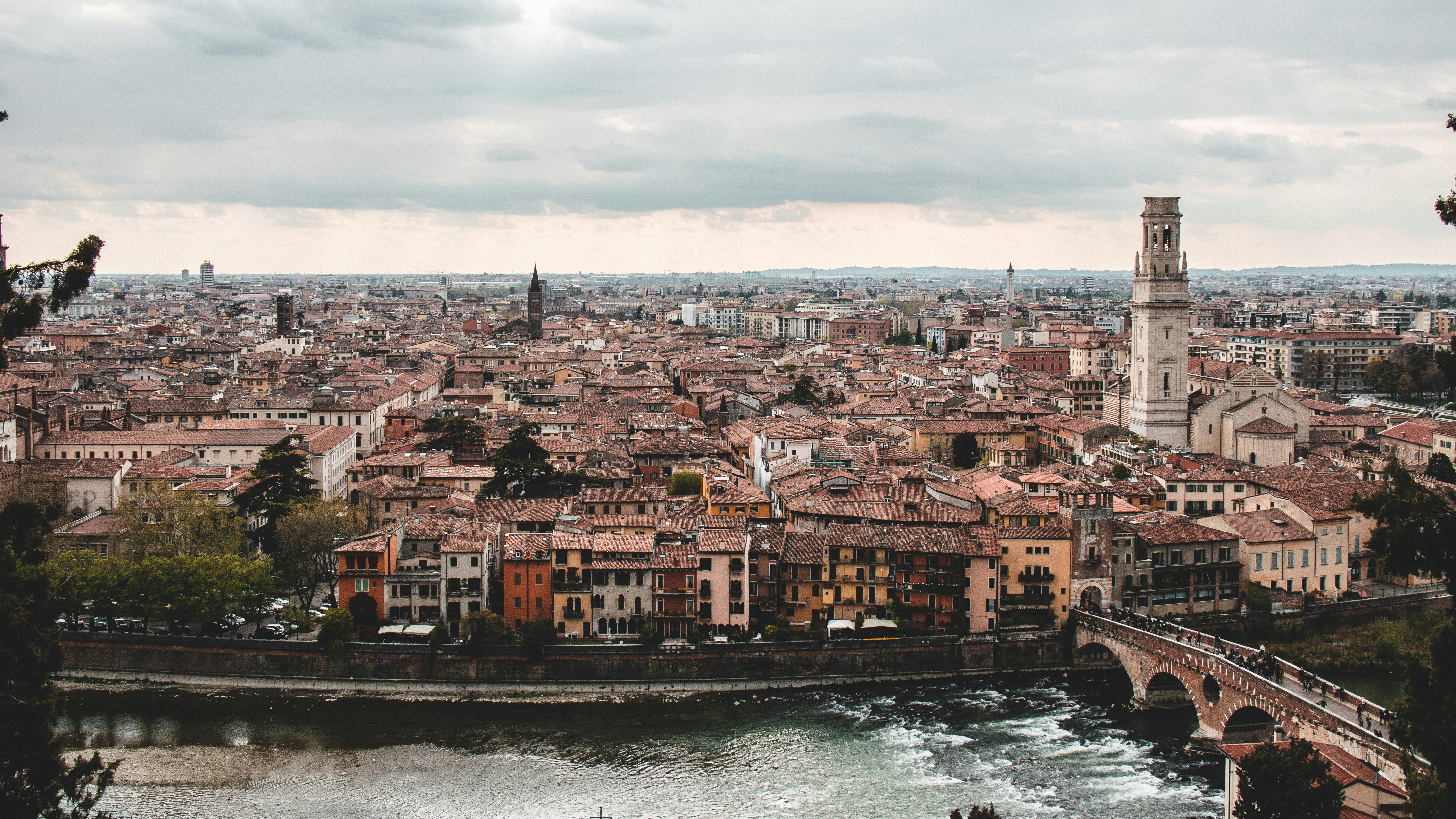 A river running through a city next to tall buildings photo – Free ...