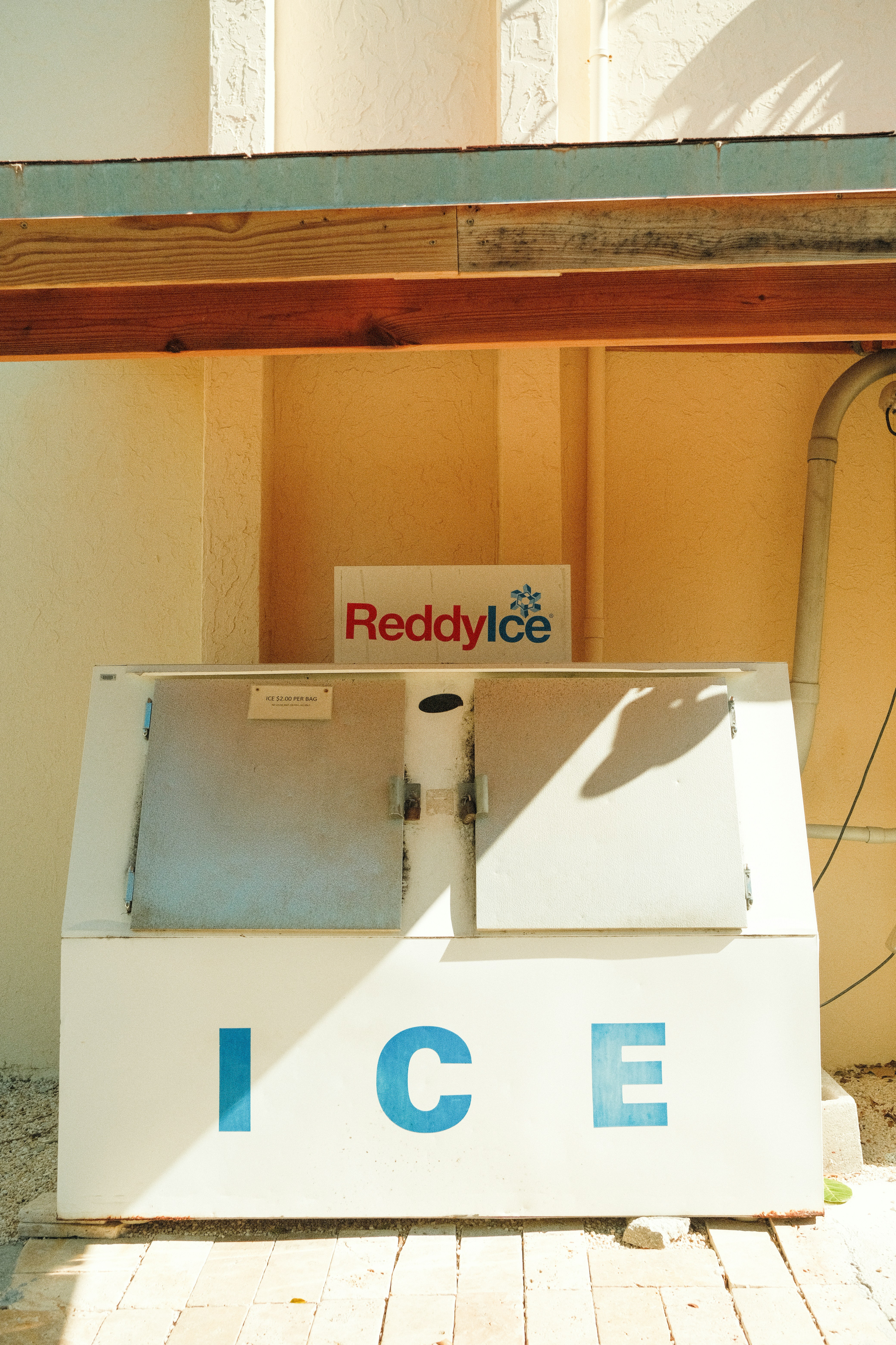 A white ice box sitting under a wooden roof photo – Free Usa Image on ...