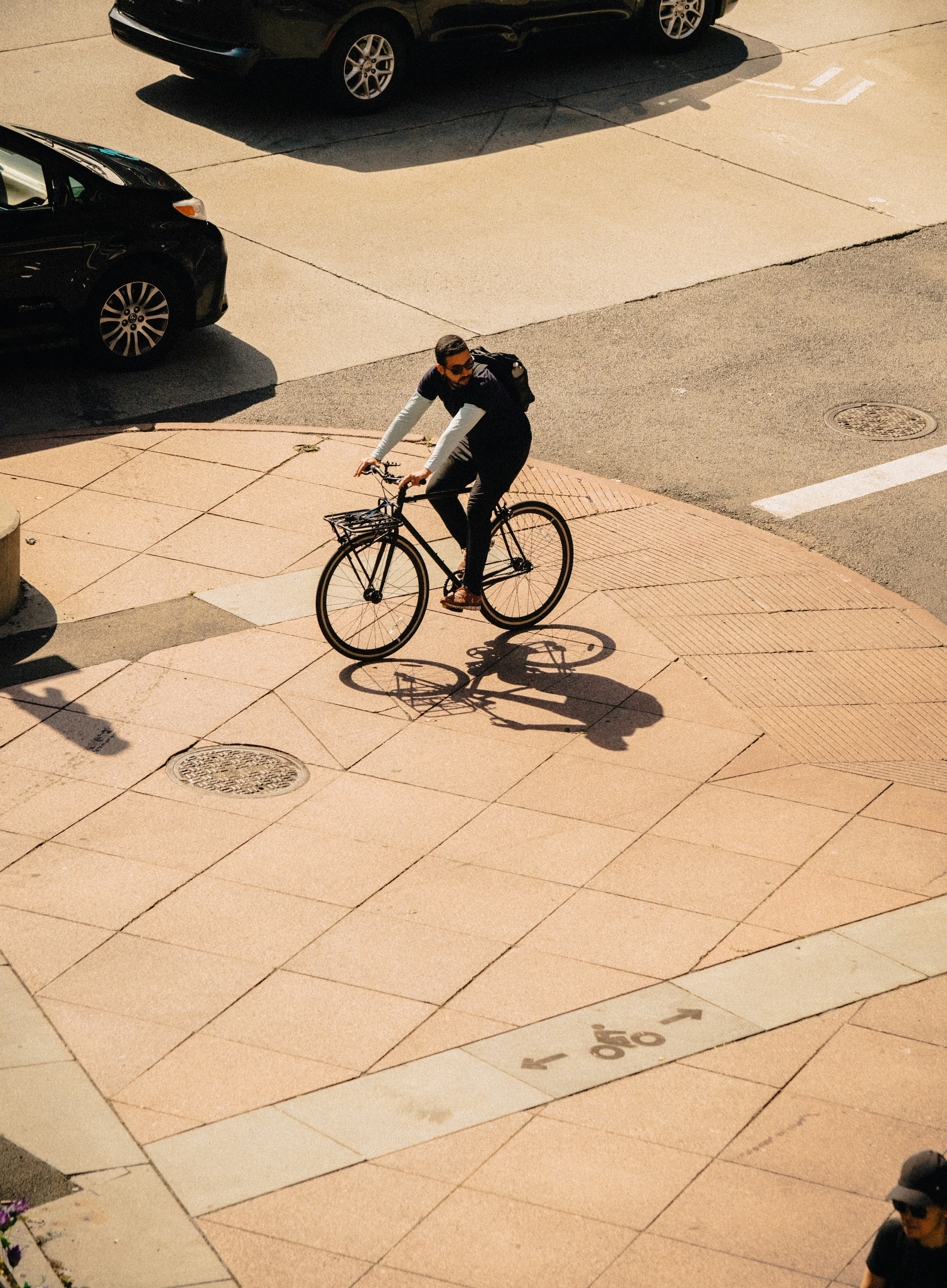A person riding a bike on a city street photo – Free Biker Image on ...