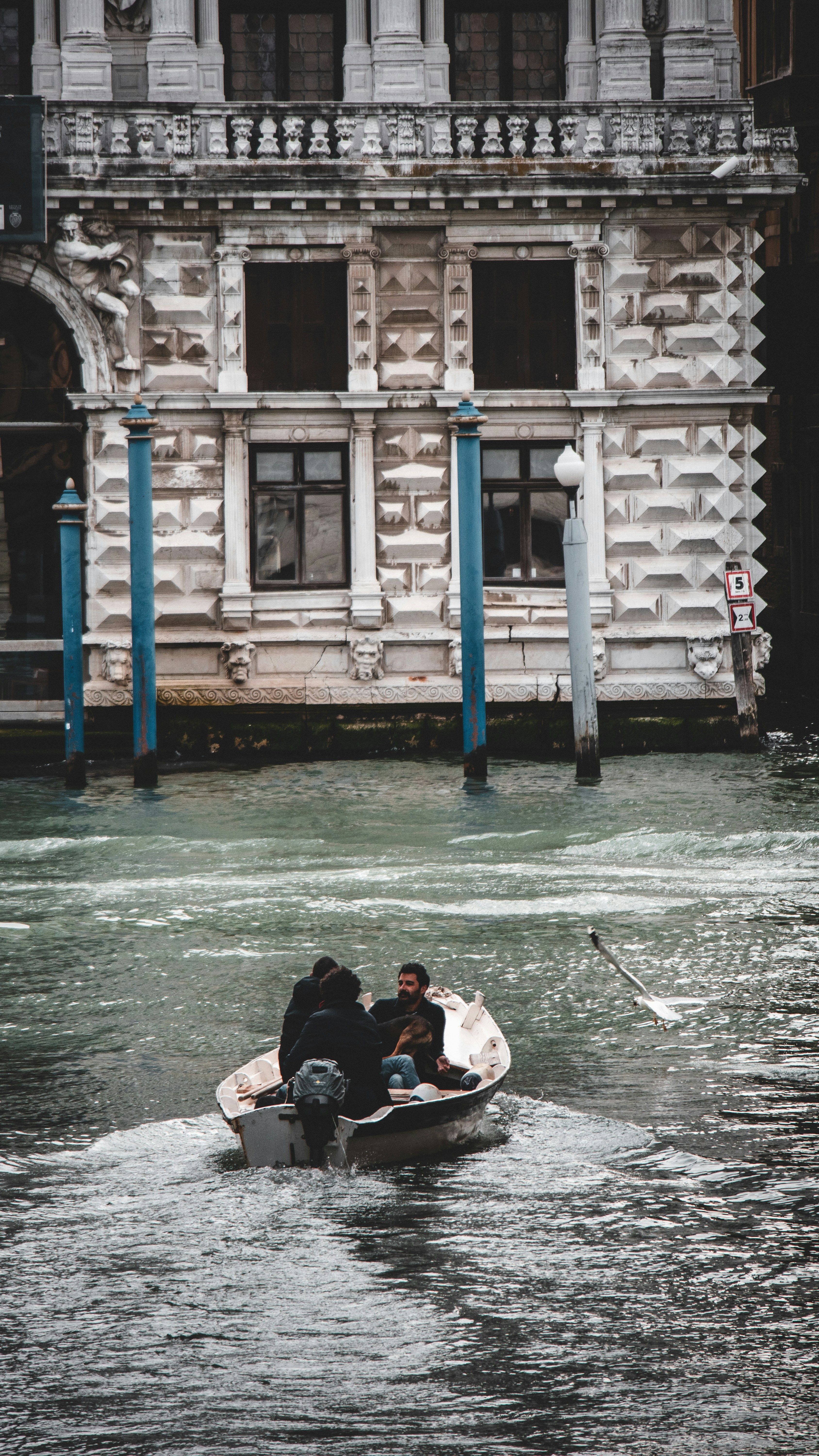 Diamond Facade Crossing: A Small Boat Glides Through a Historic Canal