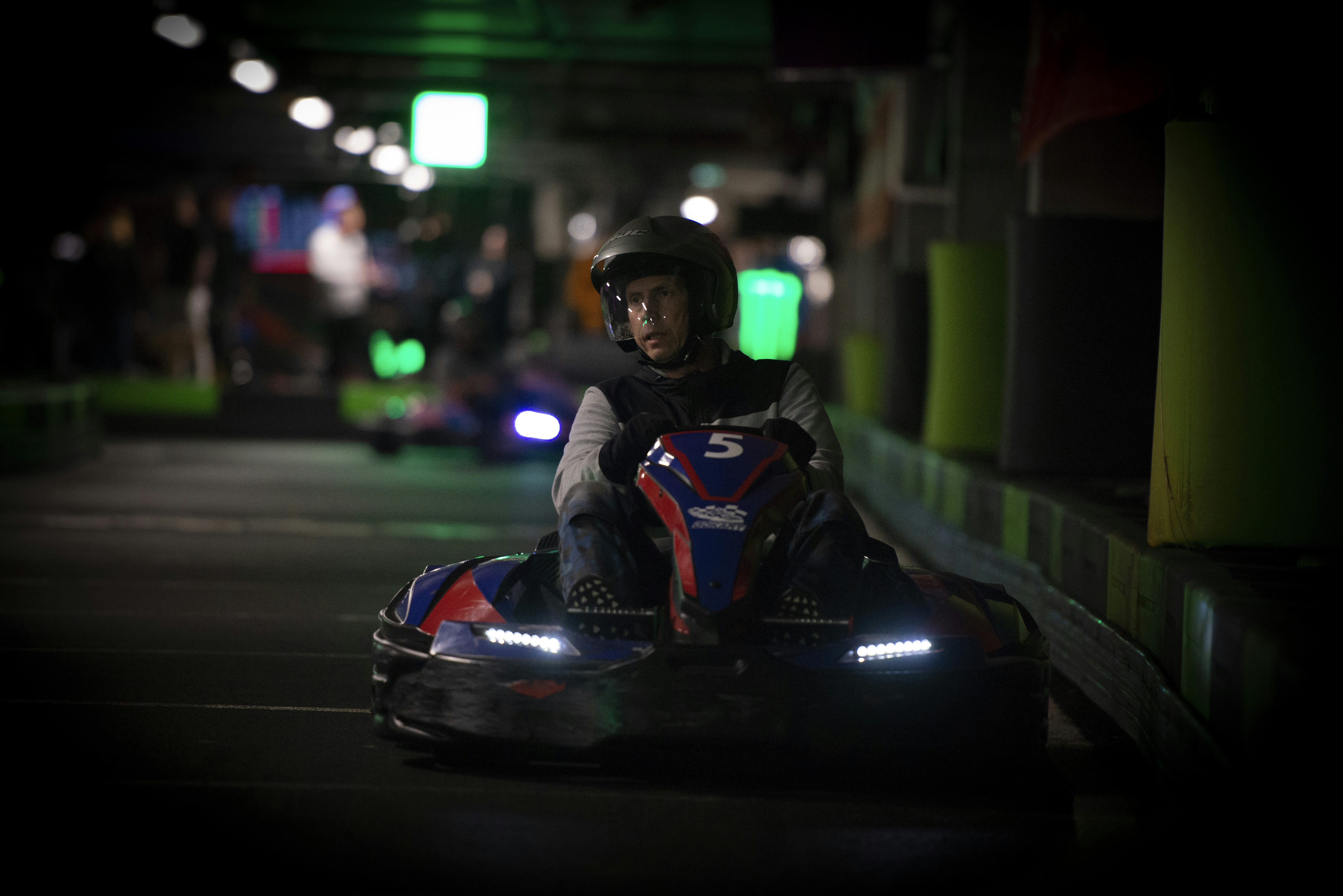 Front-View Racer: The Go-Kart Streaks Ahead in a Neon Night Track