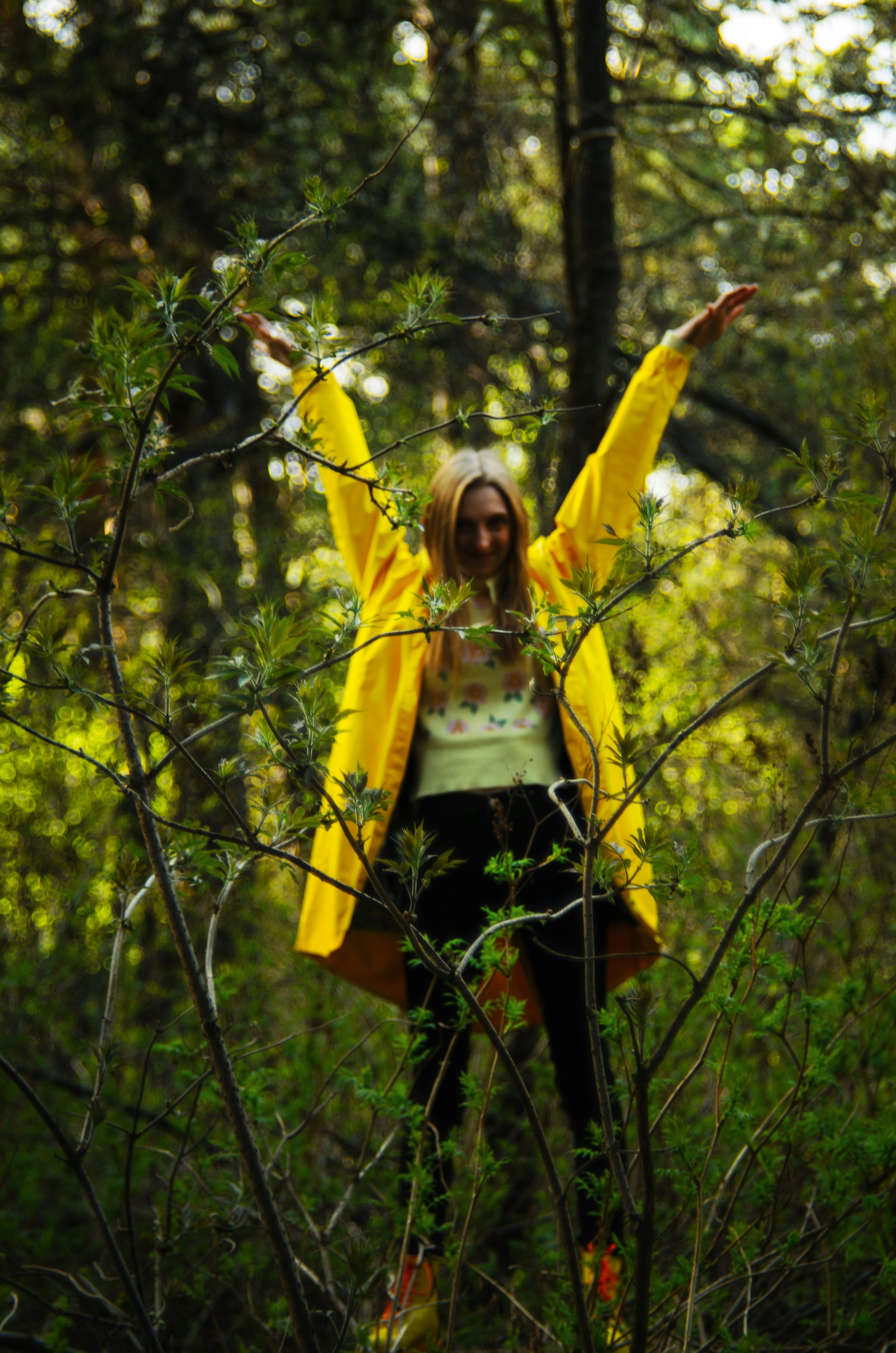 Shout of Yellow: A Woman with Arms Raised in a Sunlit Forest