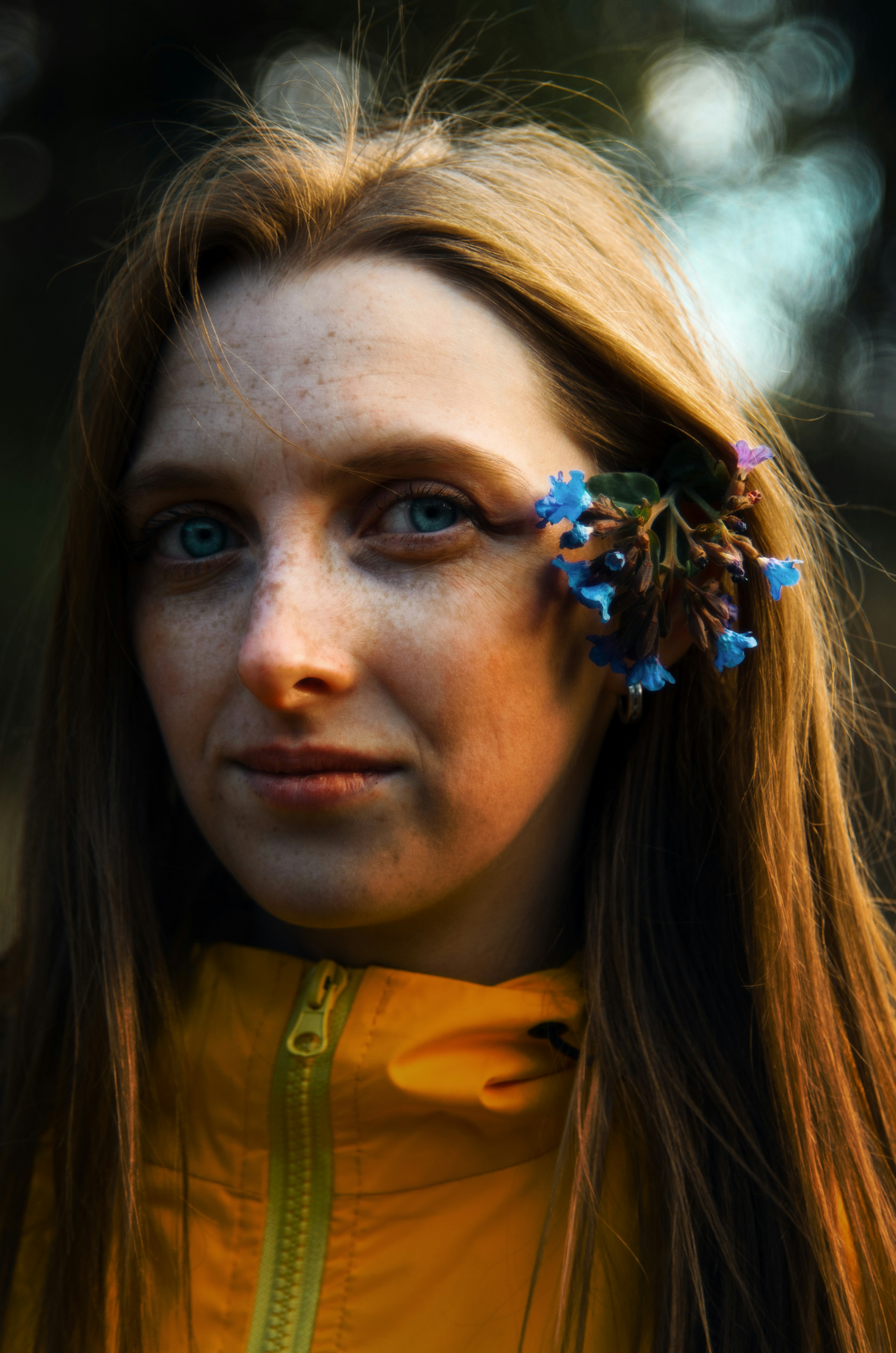 Blue-Eyed Portrait in Golden Light with a Floral Accent
