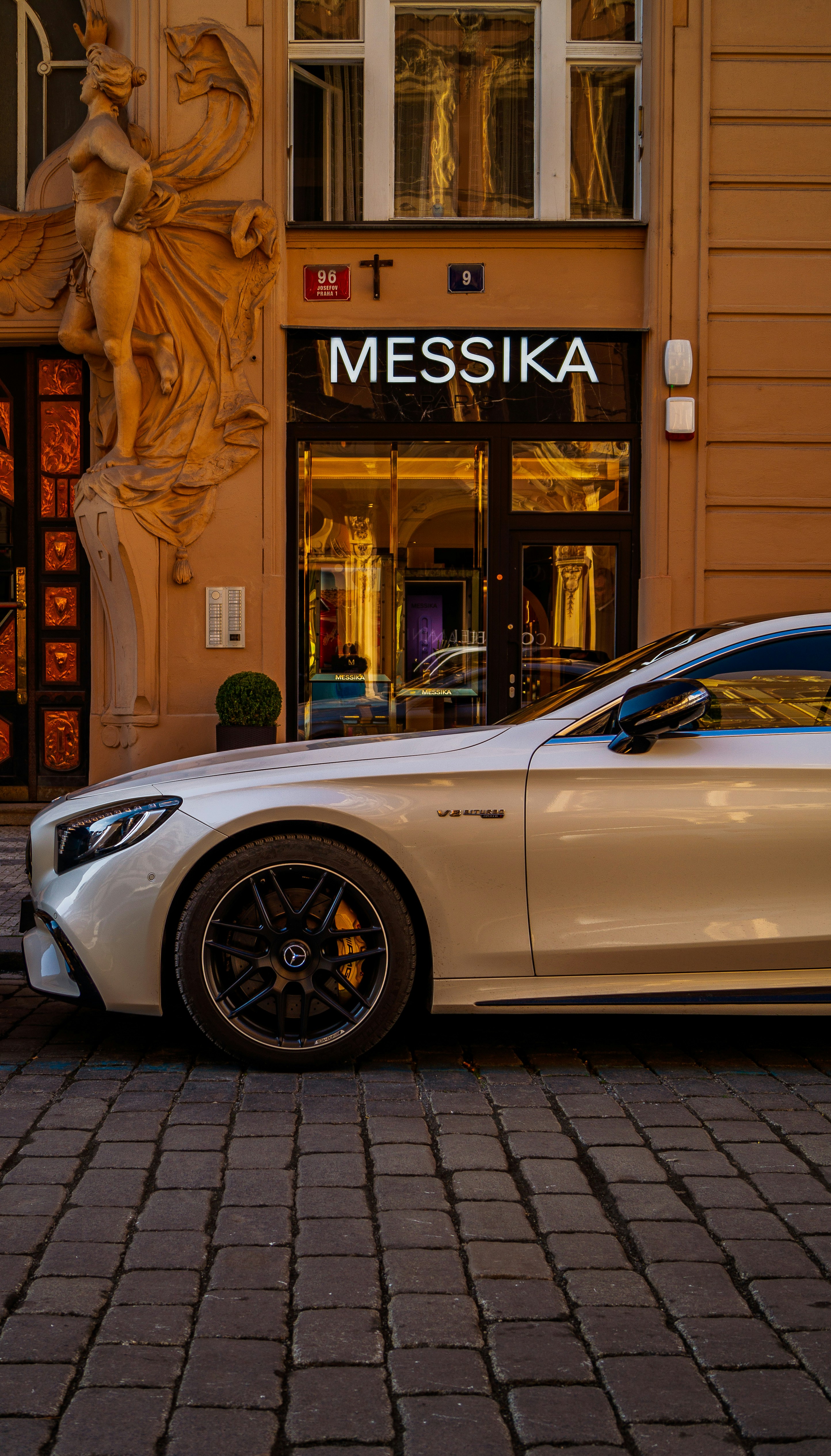 Shaded Street, Silver Cruiser: A Mercedes Stalwart in Front of a Fashionable Boutique