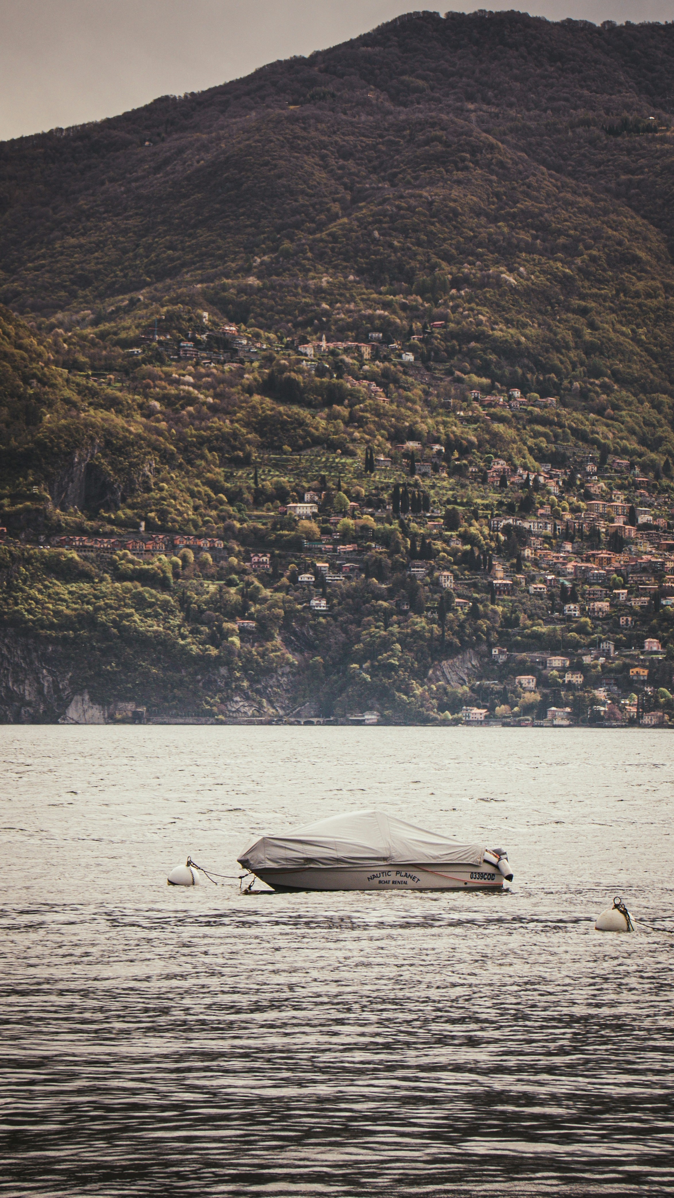 Boat Slumber on a Quiet Lake Under a Verdant Slope