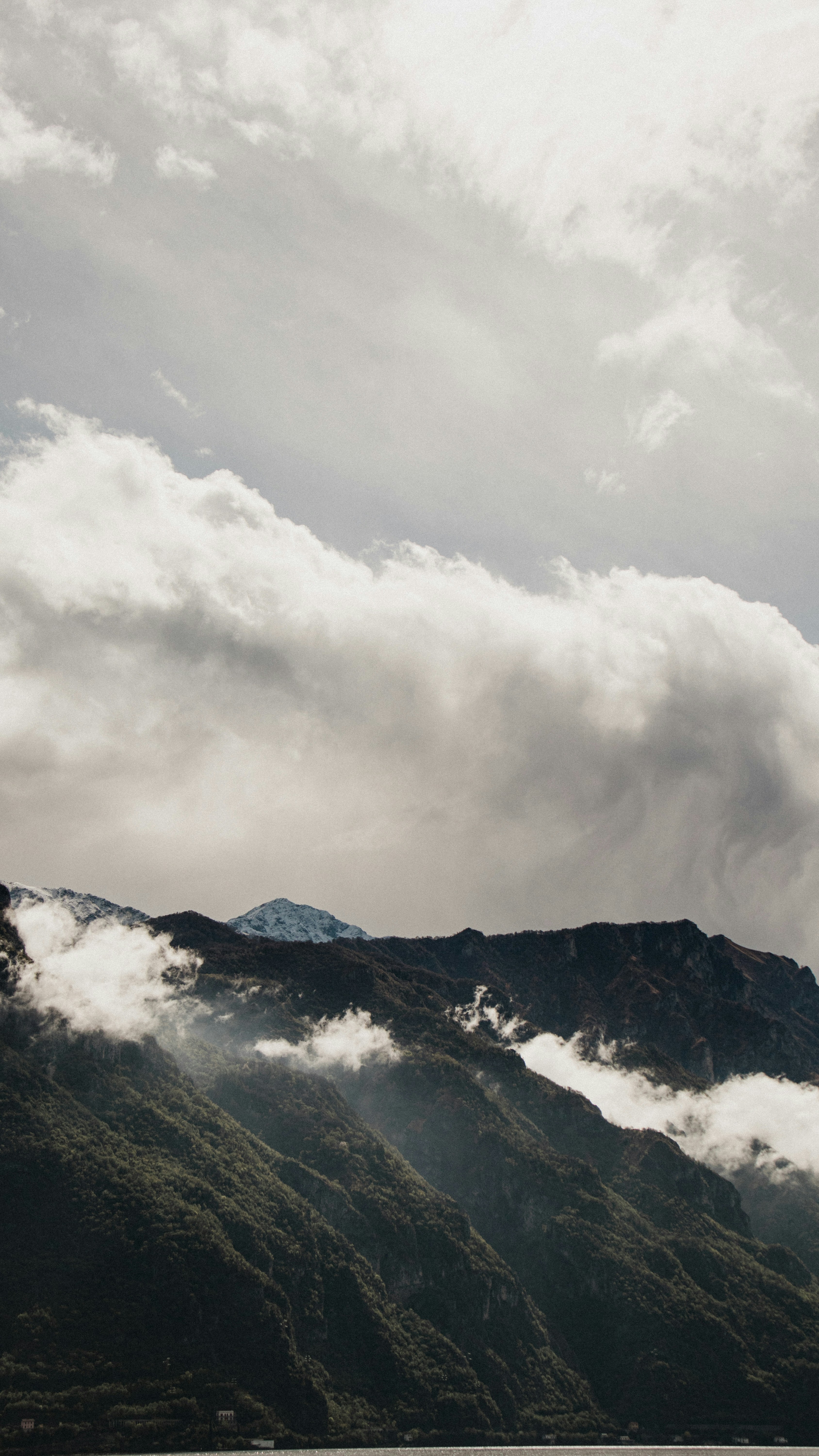 A mountain range with clouds in the sky photo – Free Wallpaper Image on Unsplash