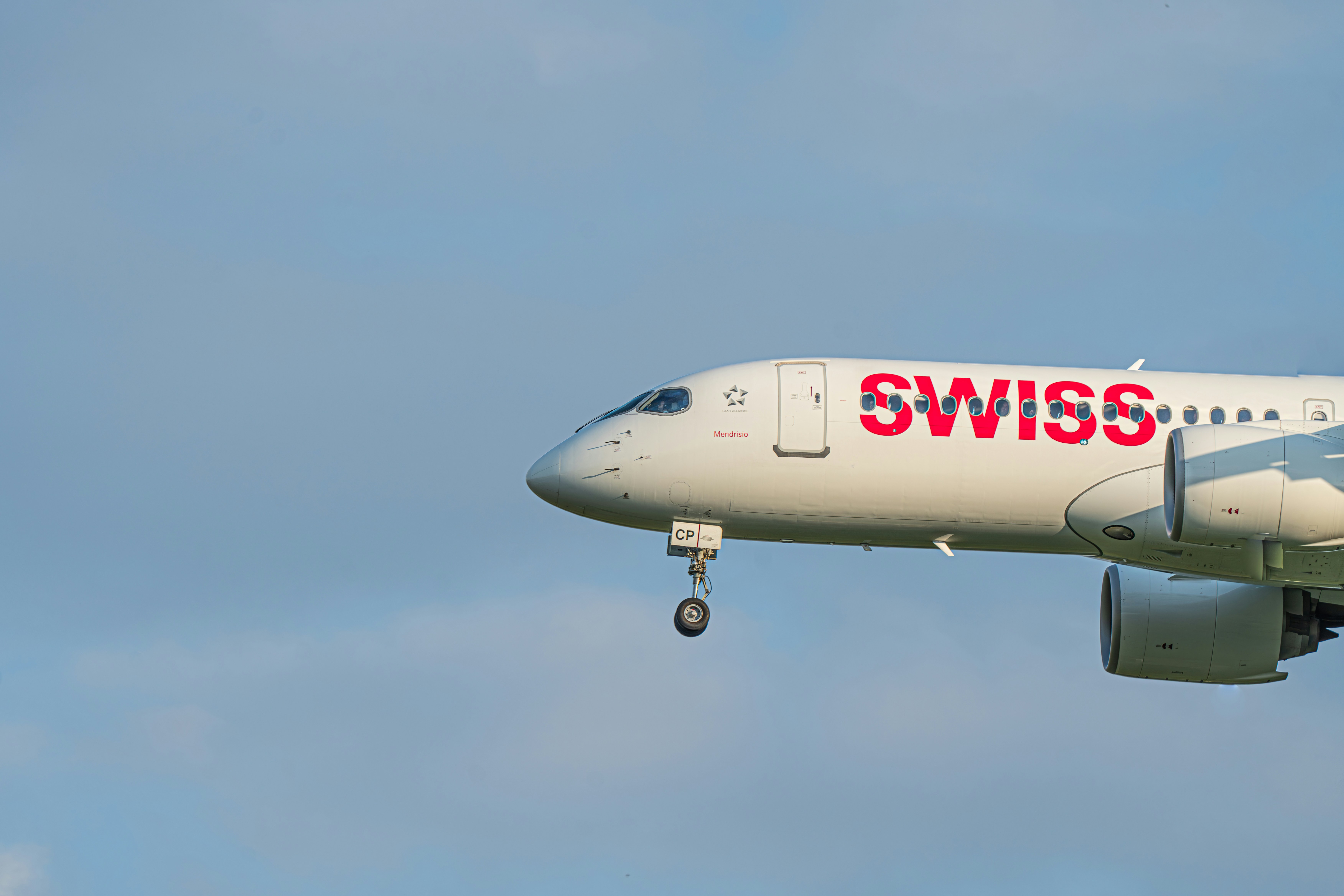 A white and red swiss airplane flying in the sky photo – Free Frankfurt ...
