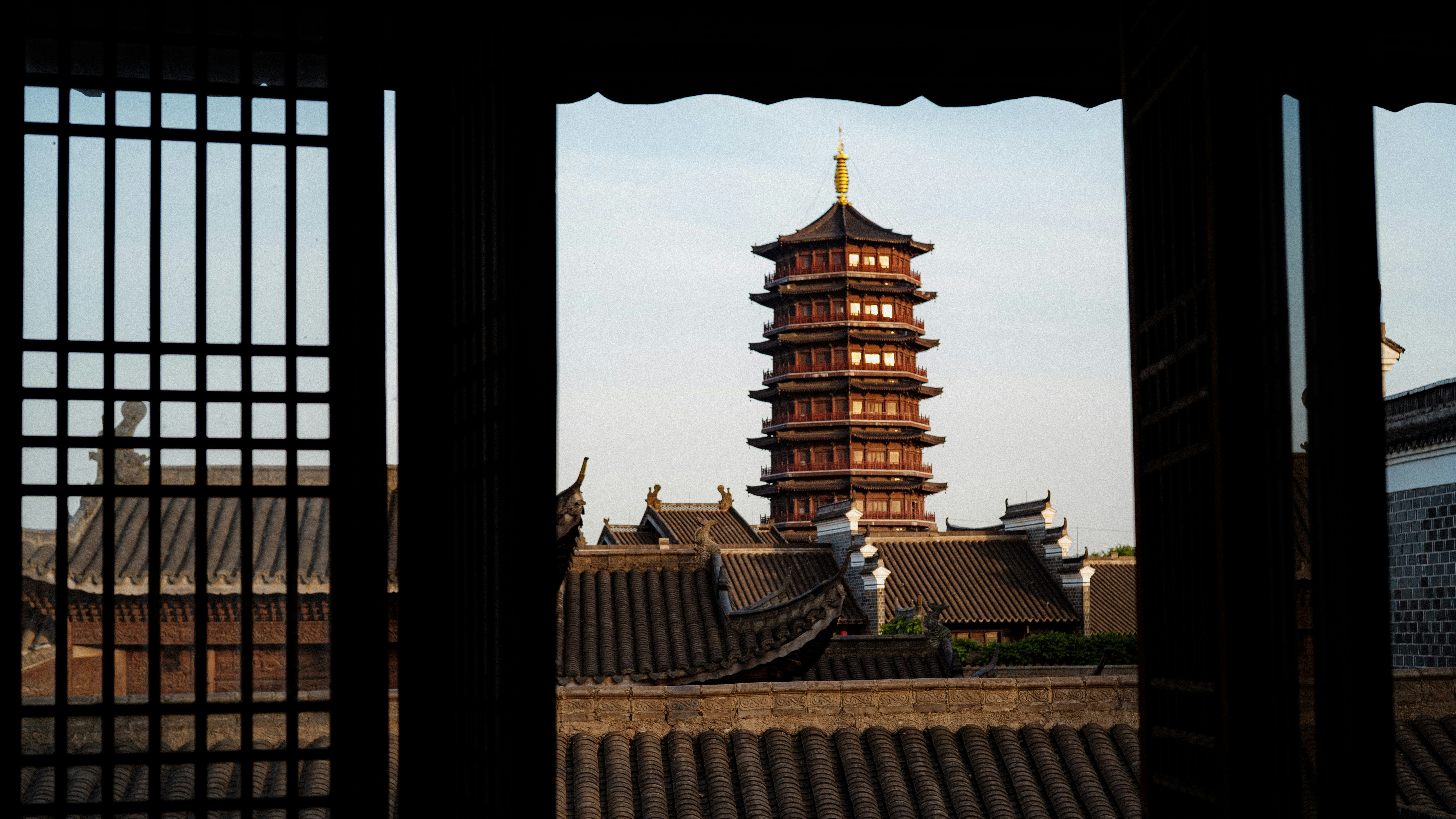 A view of a tall tower through a window photo – Free Building Image on ...