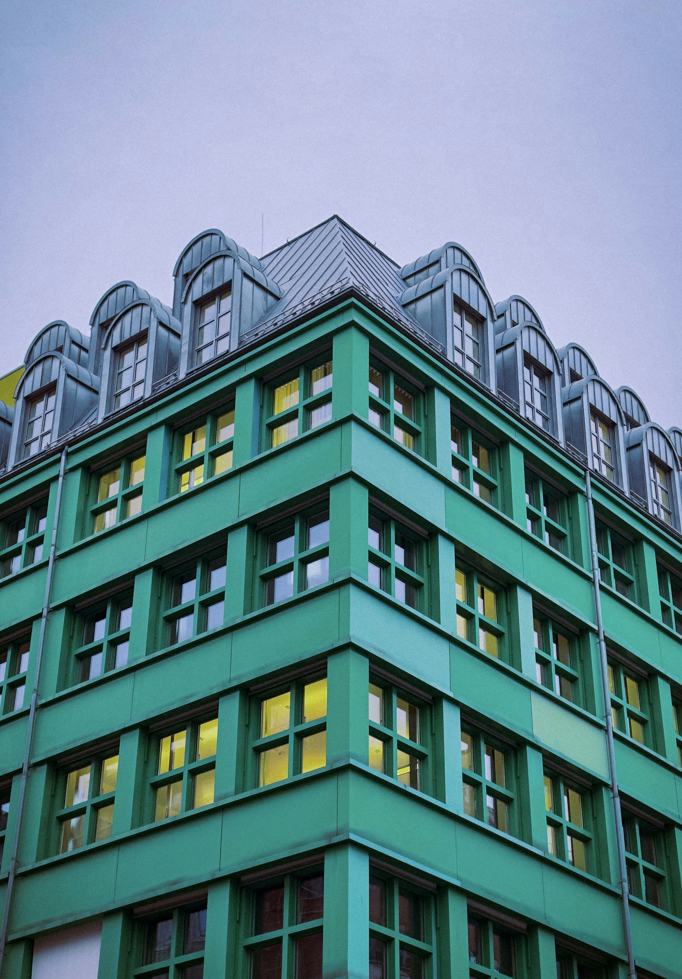 A tall green building with lots of windows photo – Free Germany Image ...