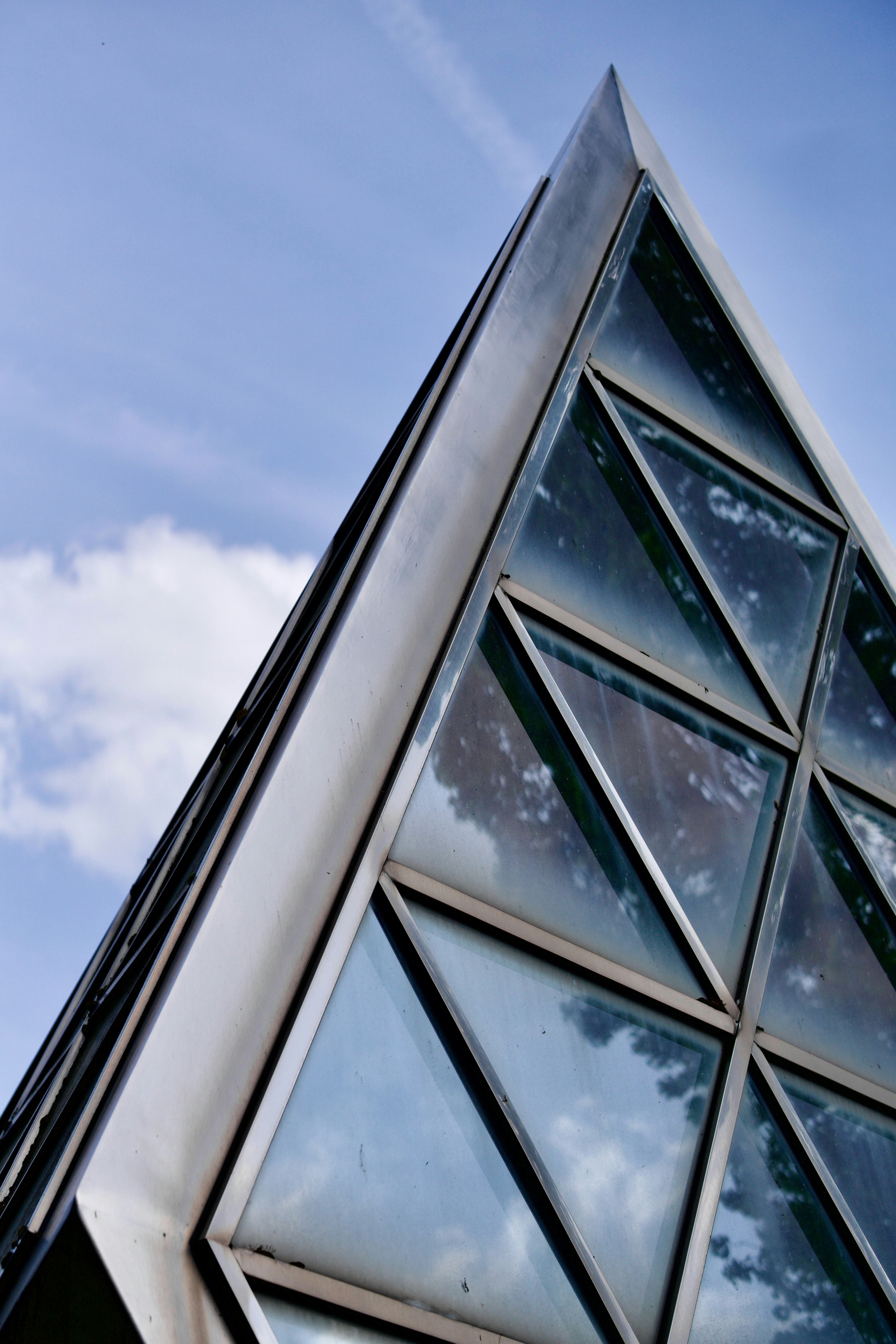 A triangular shaped building with a sky background photo – Free ...