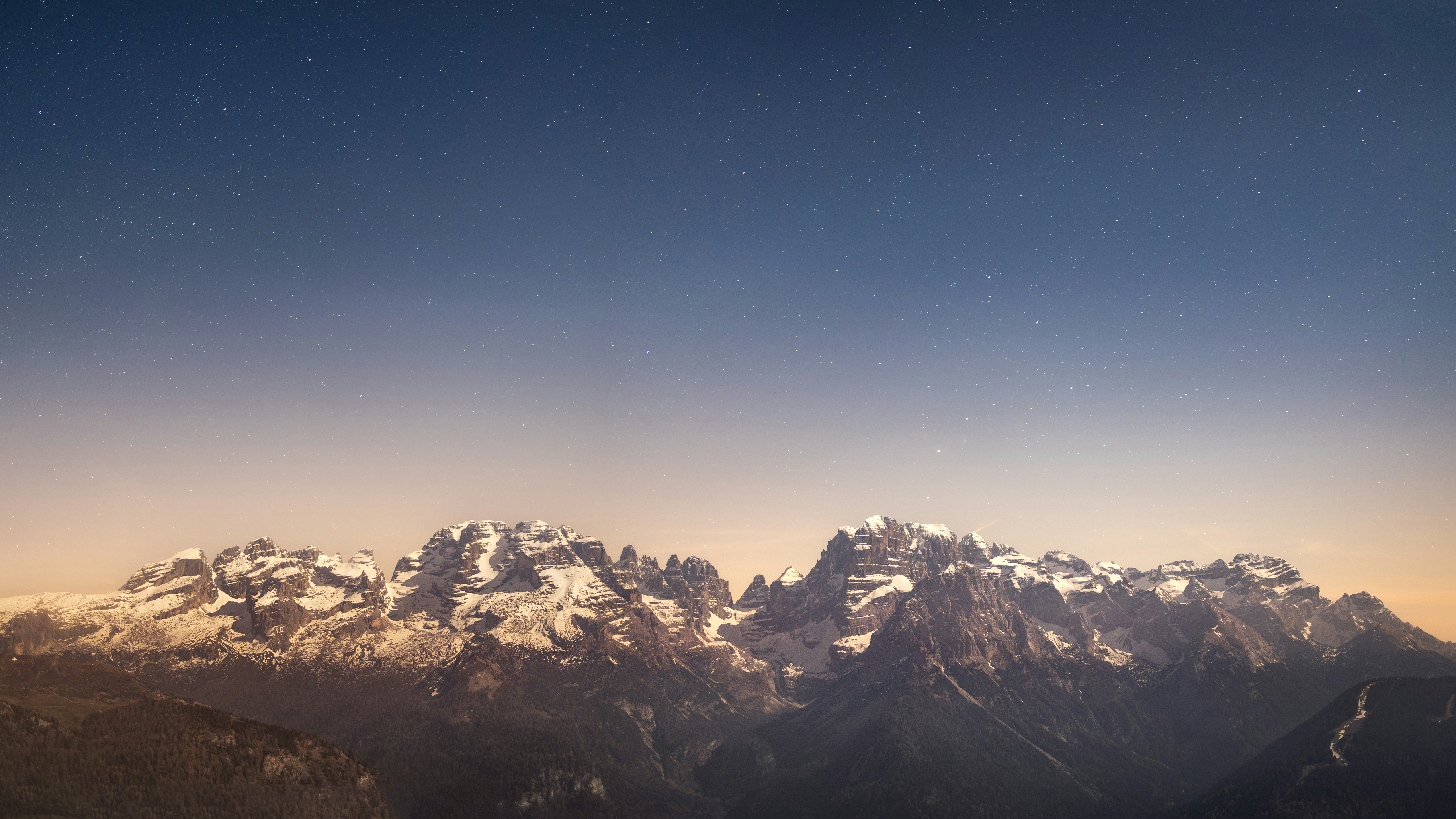 A view of a mountain range at night with stars in the sky photo – Free ...