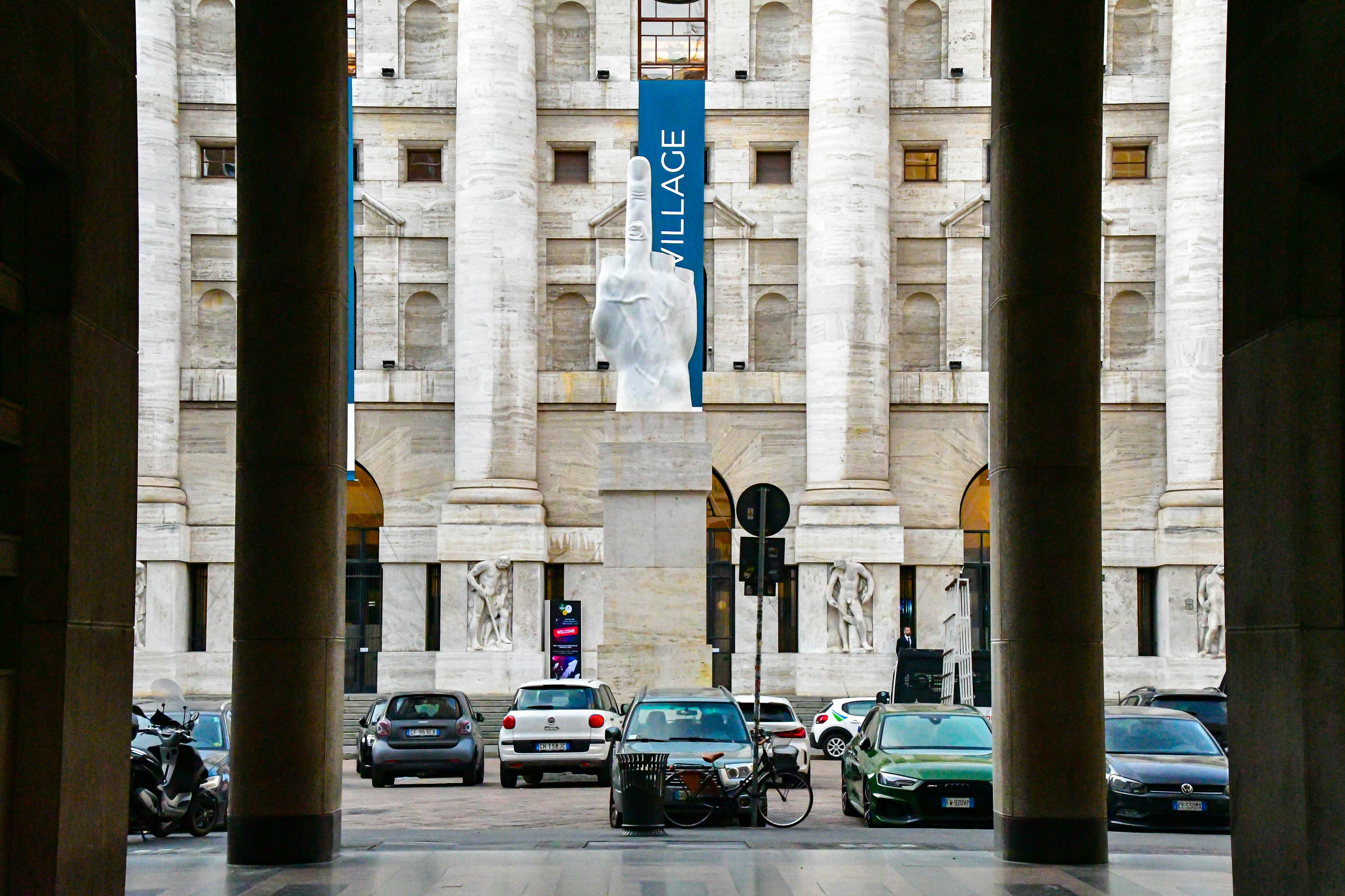 Bannered Facade Under a Classical Colonnade: A Quiet City Moment