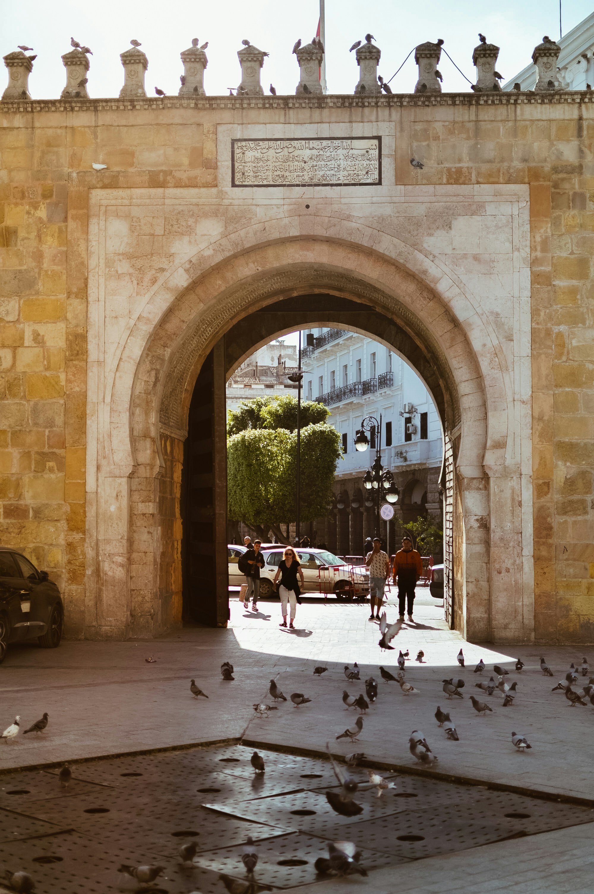 Eine Gruppe von Menschen, die unter einem Torbogen hindurchgehen Foto ...