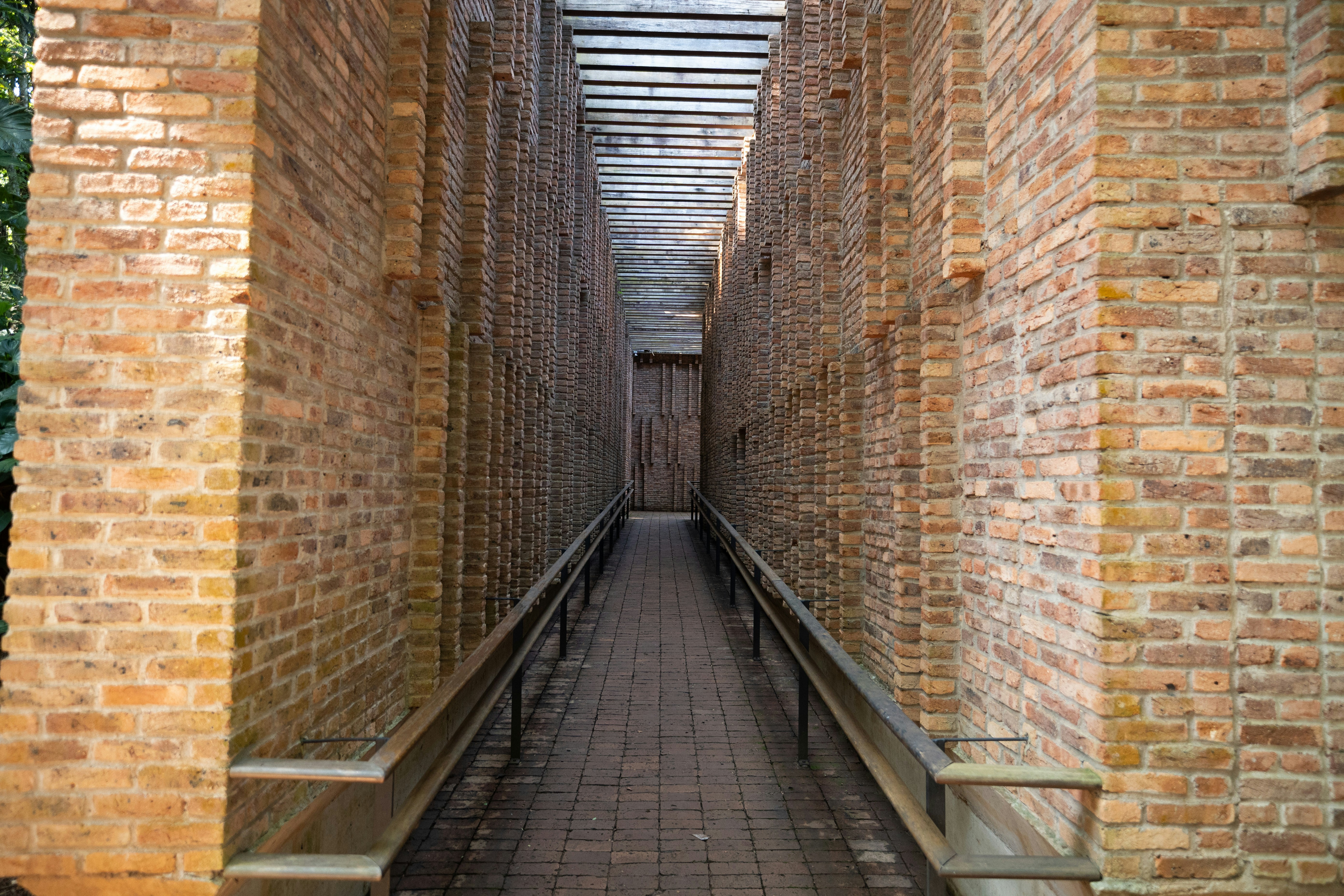 A narrow walkway between two brick buildings photo – Free Alley Image ...