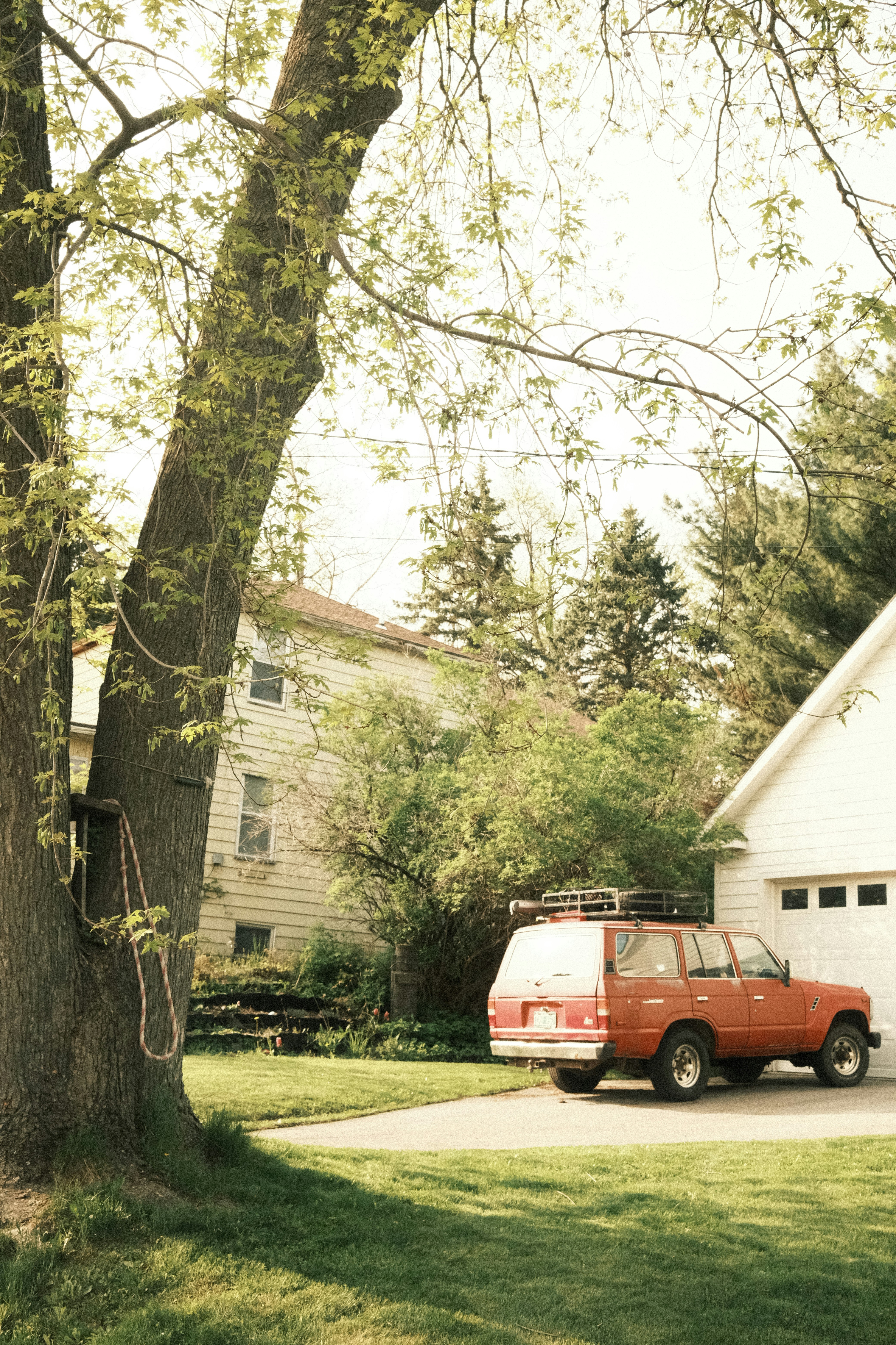 Red Street-Ready Utility: A Retro SUV in a Quiet Suburban Driveway
