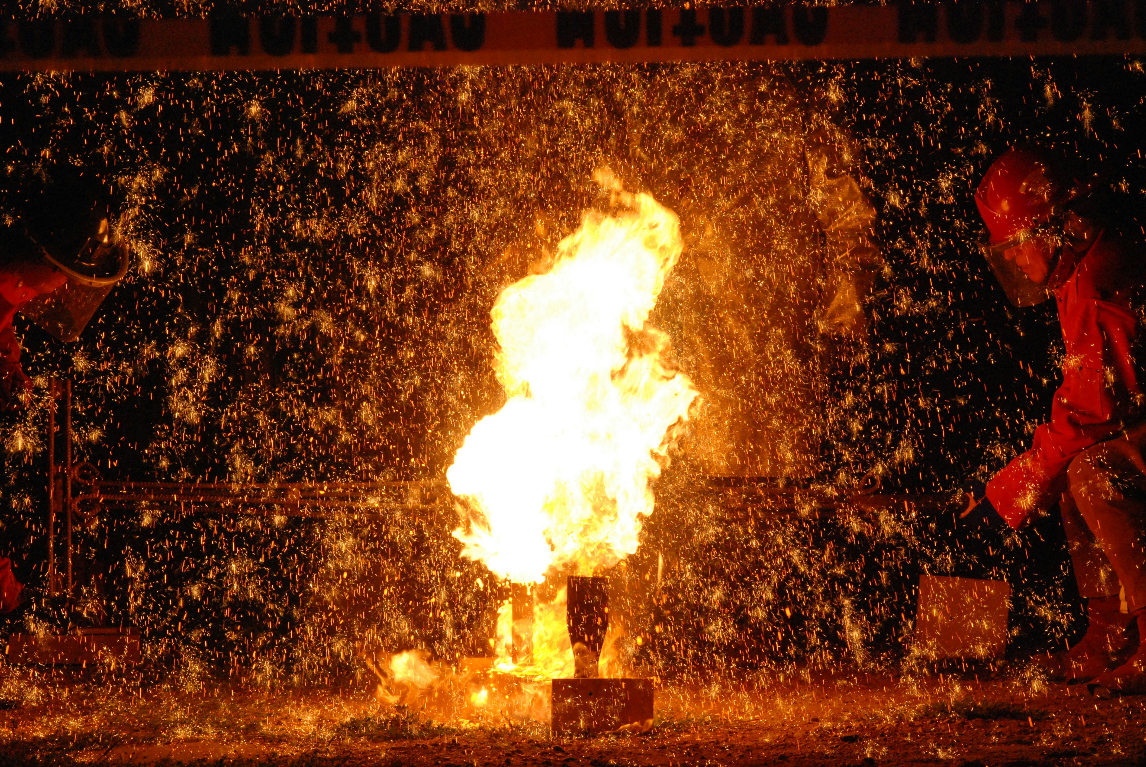 Two people standing around a fire in the dark photo – Free Boy Image on ...