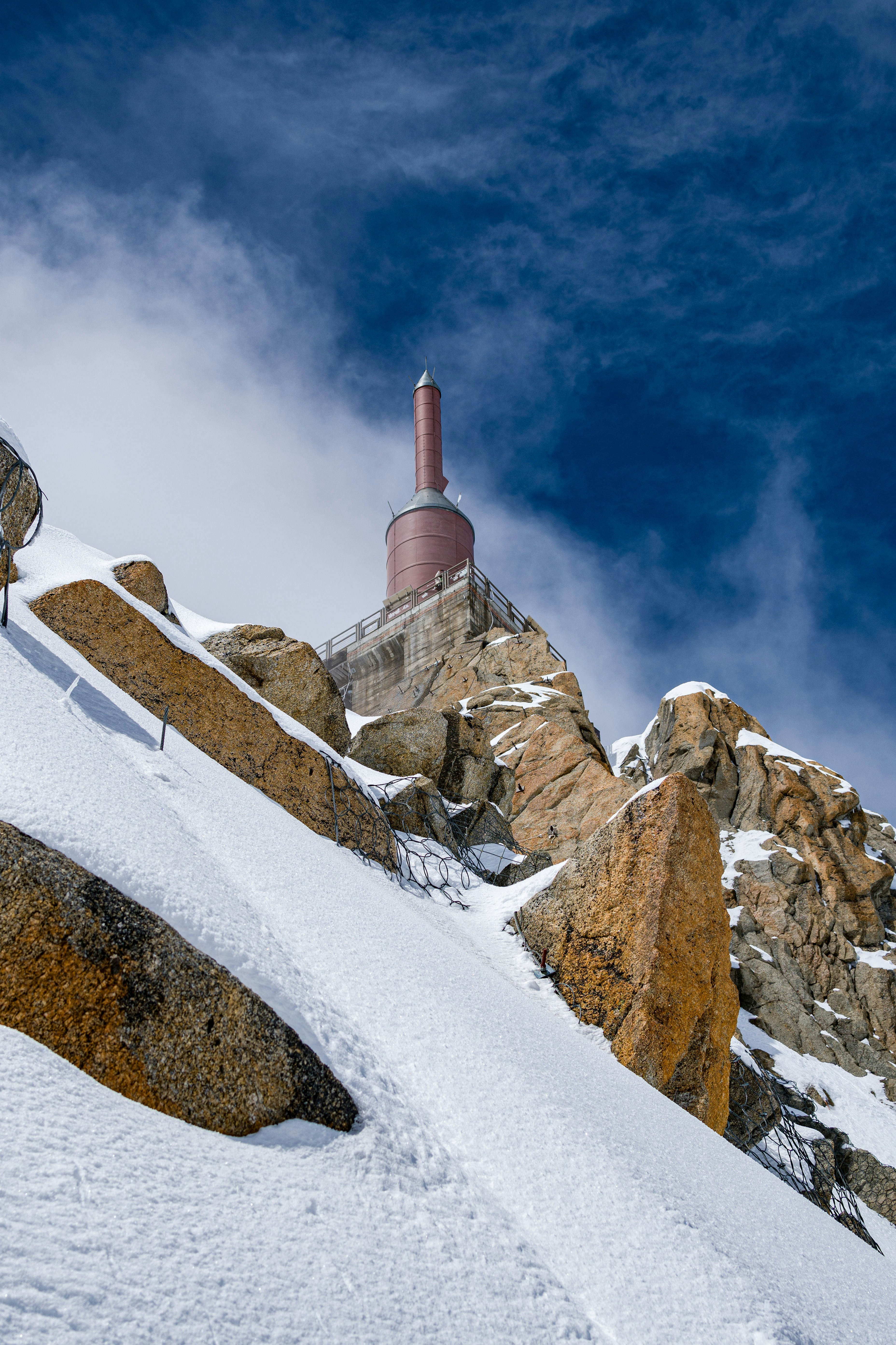 A lighthouse on top of a mountain covered in snow photo – Free ...