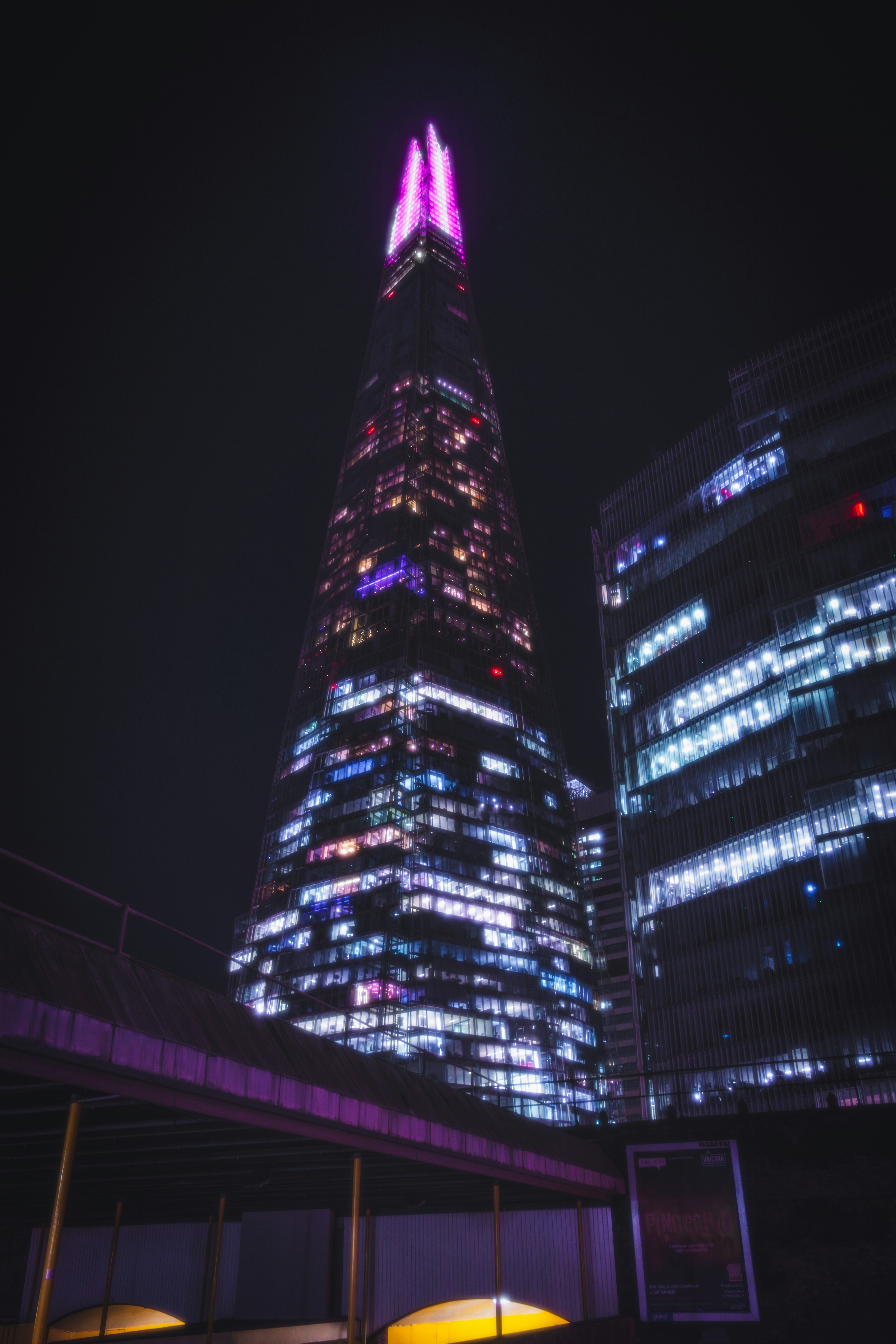 A very tall building lit up at night photo – Free London Image on Unsplash