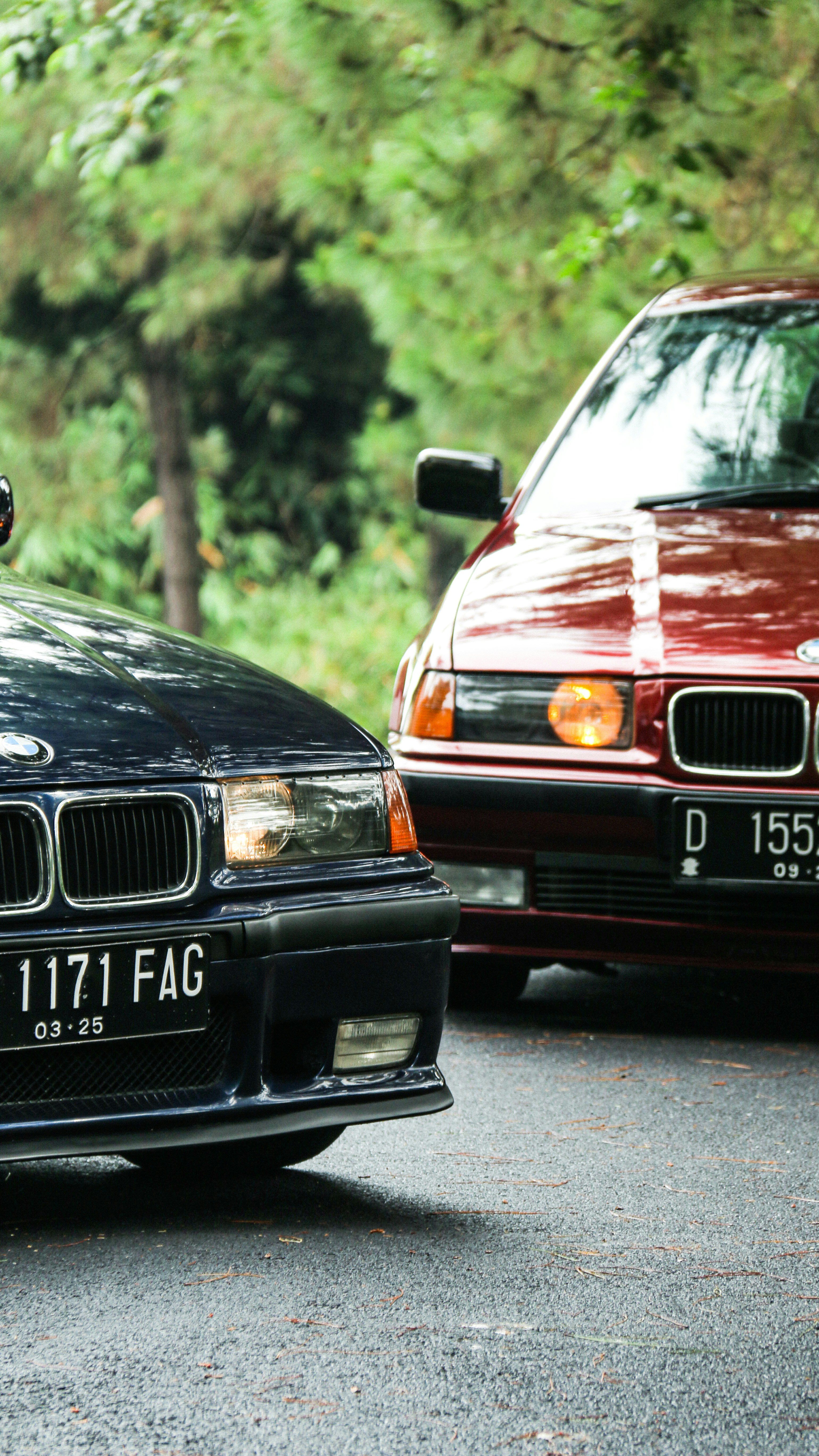 Front-Row Duel: Dark Blue and Crimson Sedans Square Off on a Quiet Street