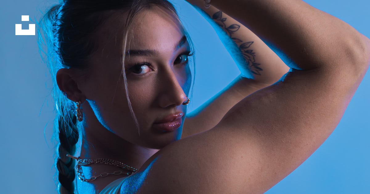 A Woman In A White Top Is Holding Her Hair Photo Free Sudbury Image