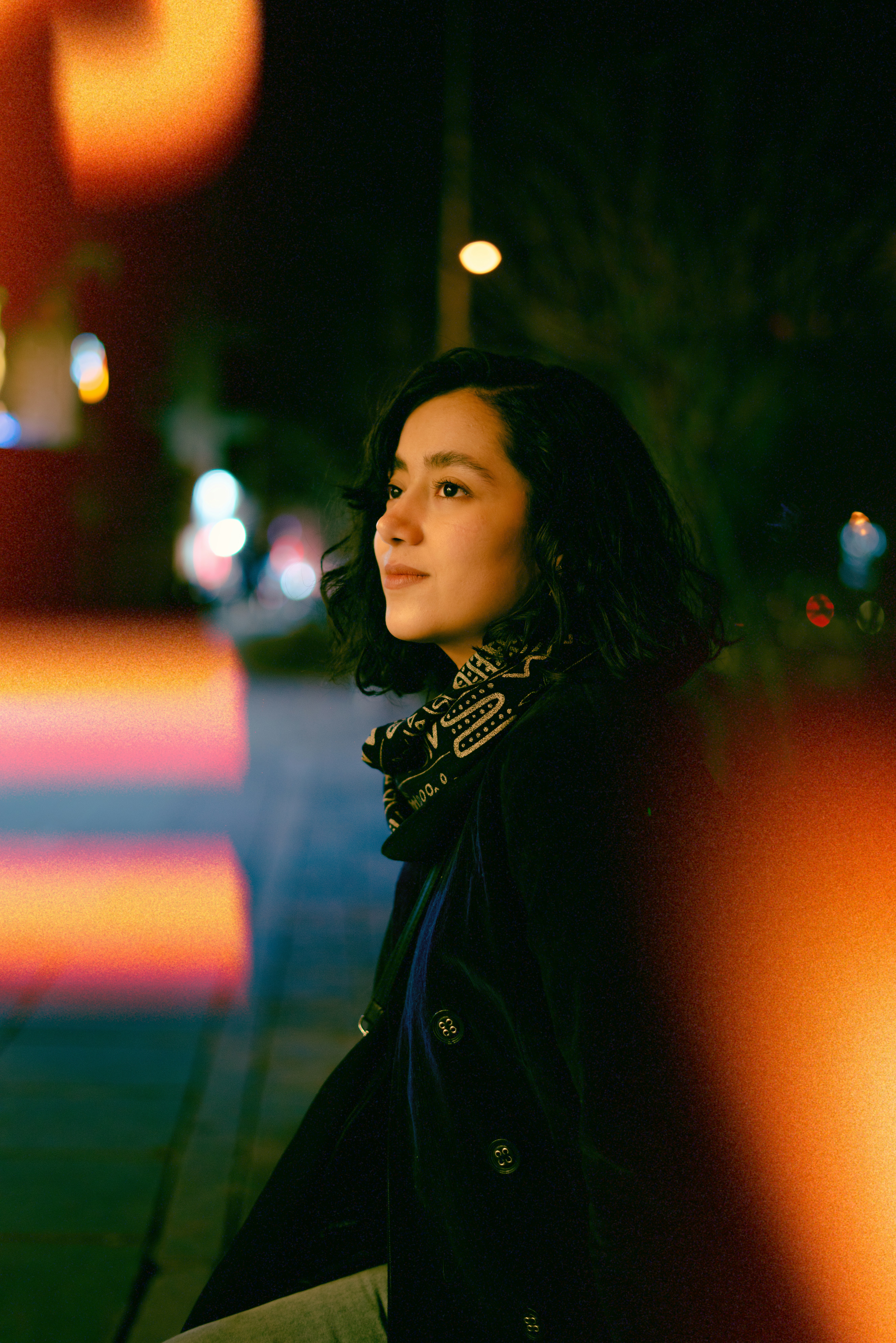 A woman sitting on a curb at night photo – Free Portrait Image on Unsplash