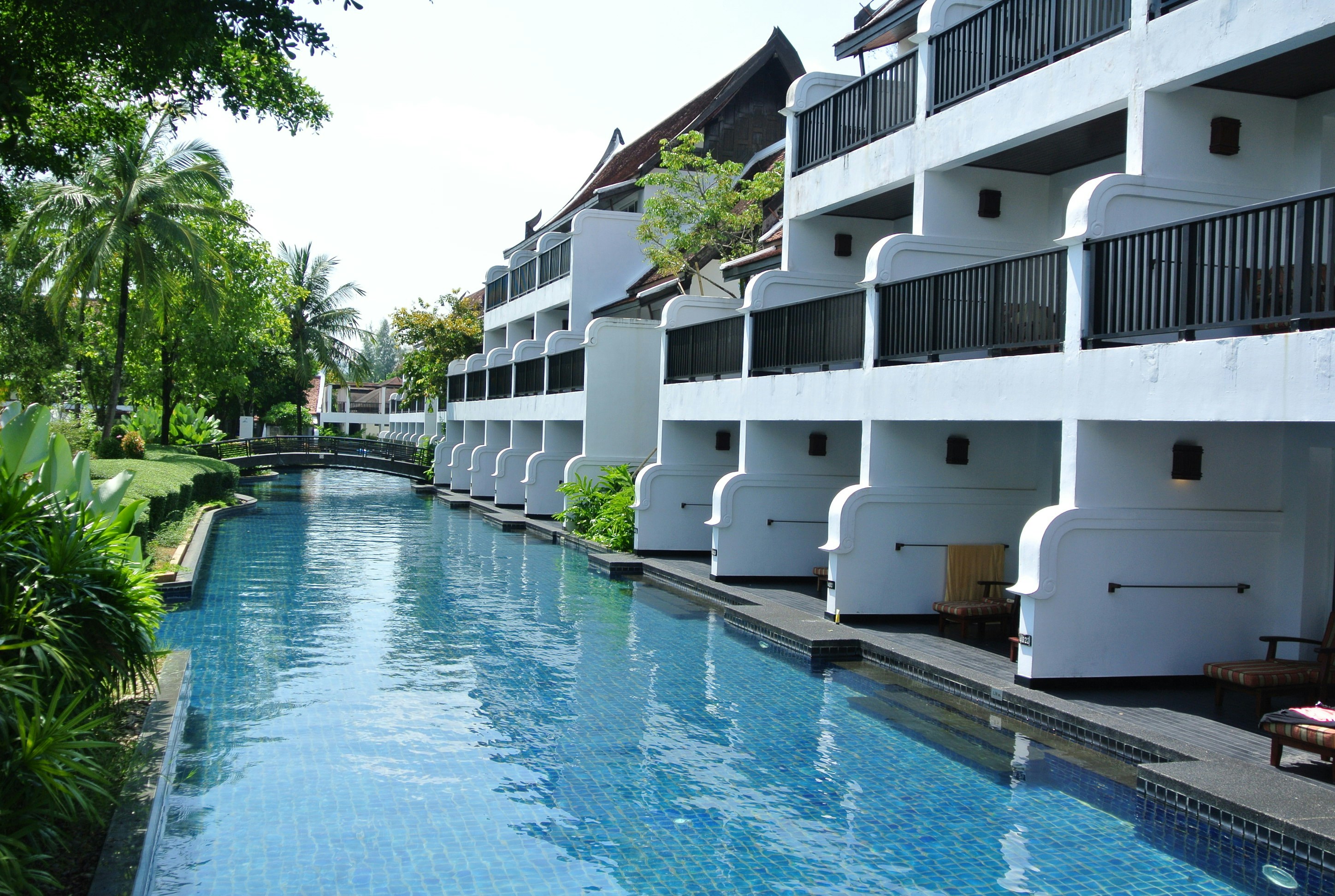 A long pool in front of a white building photo – Free Hotel Image on ...