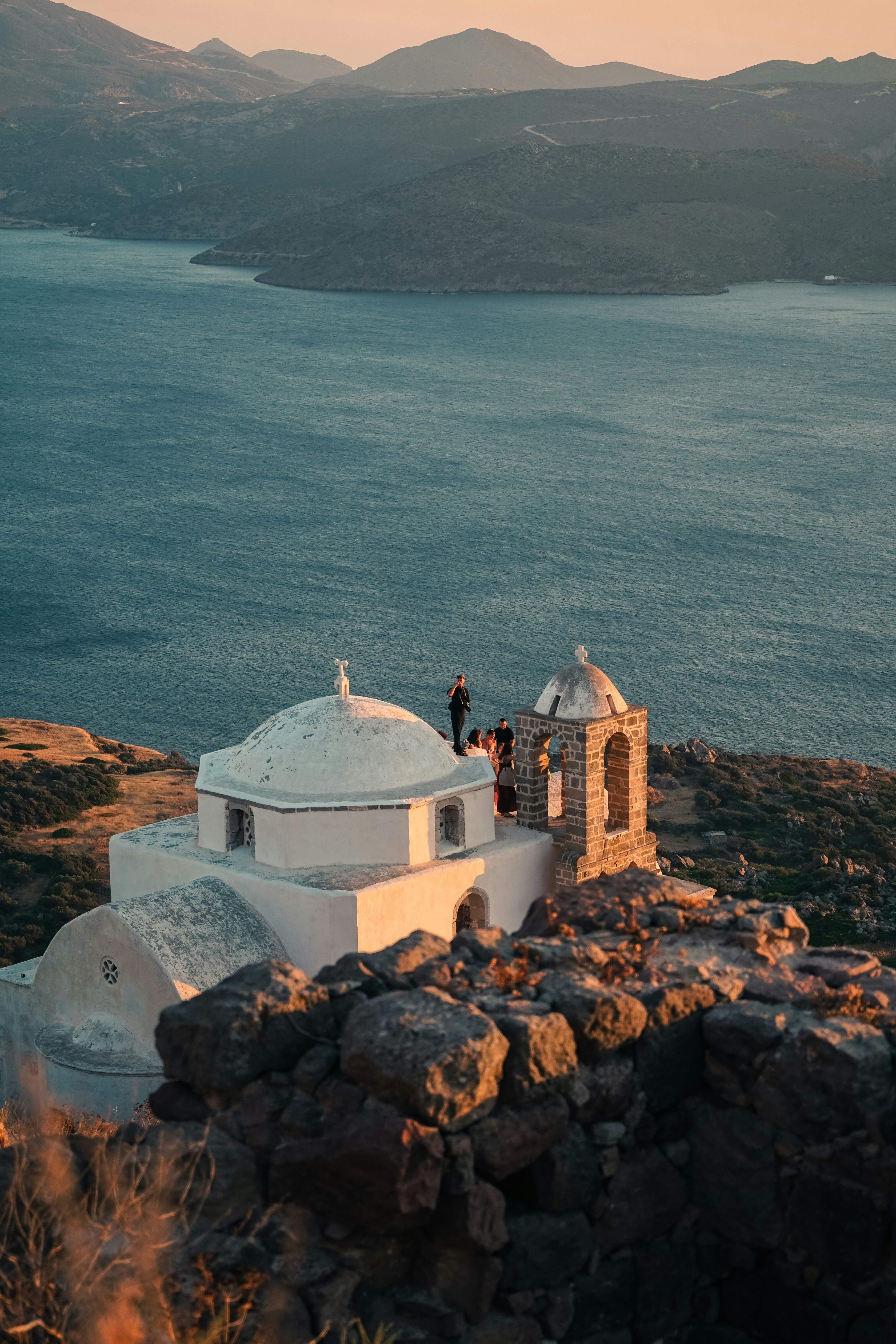 a couple of people standing on top of a hill next to a body of waterJack Castles