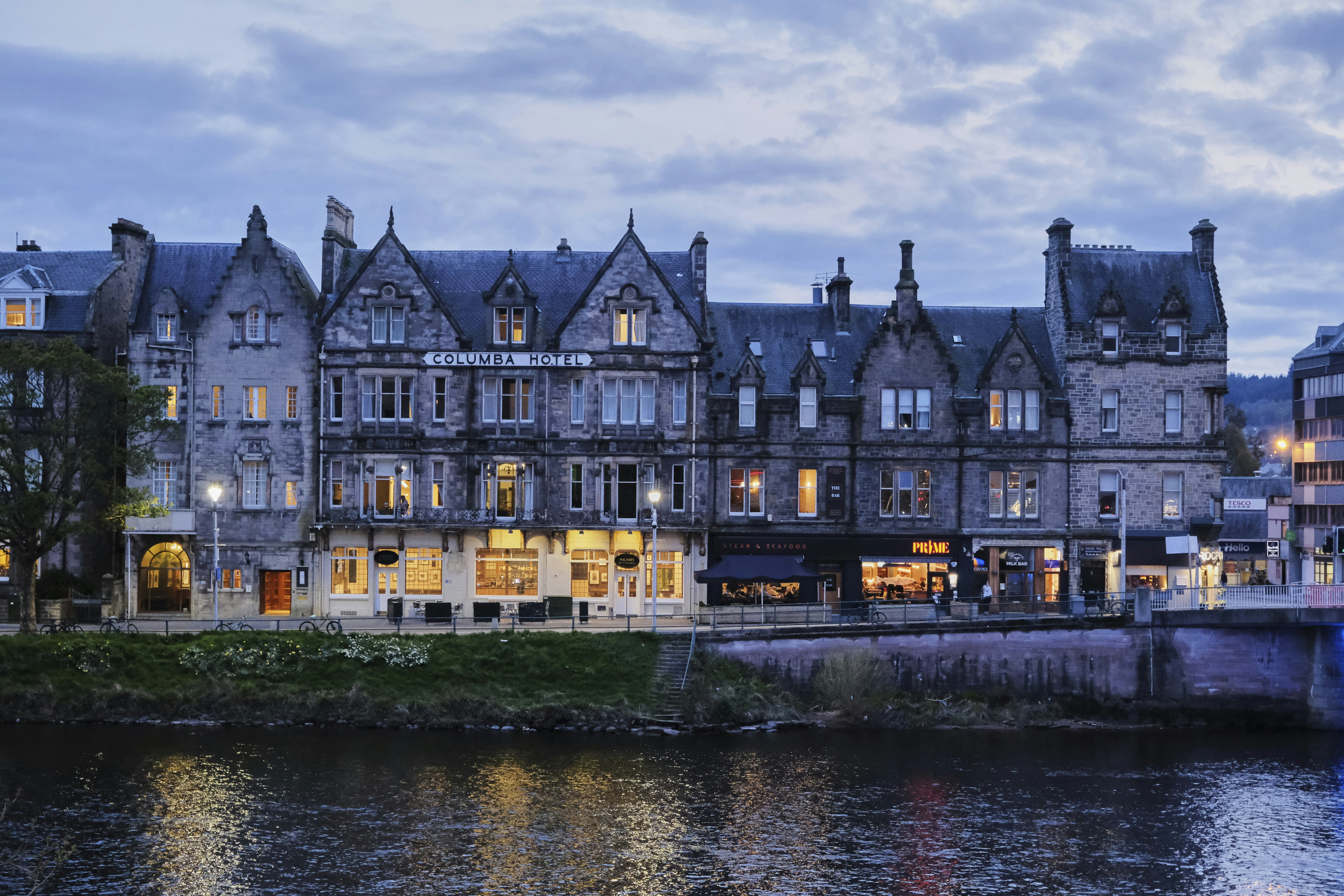 A large building next to a body of water photo – Free Inverness Image ...