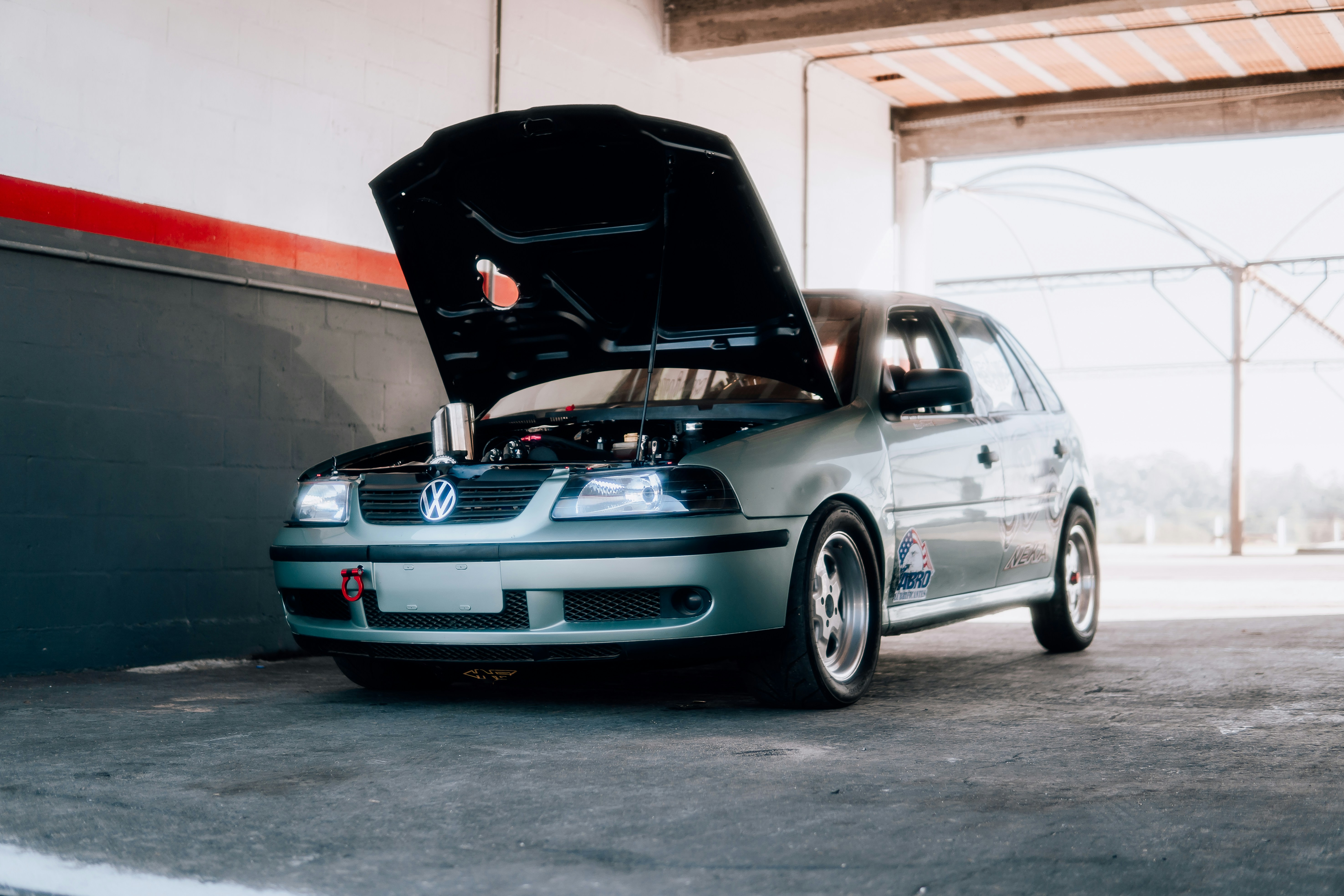 A car with its hood open in a garage photo – Free Brasil Image on Unsplash