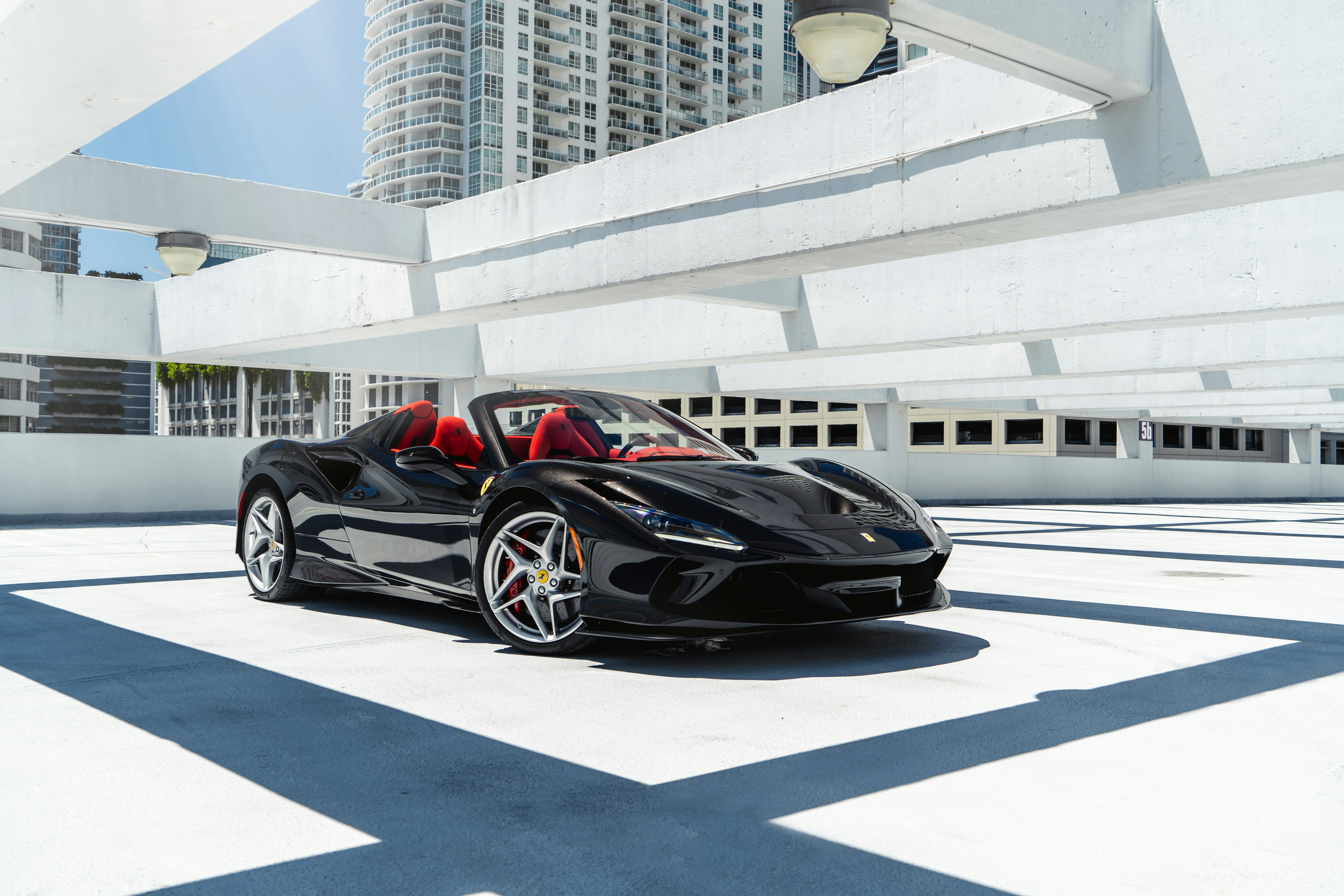 Chromed Rhythm: A Black Convertible Under Neon Shadows on a Rooftop