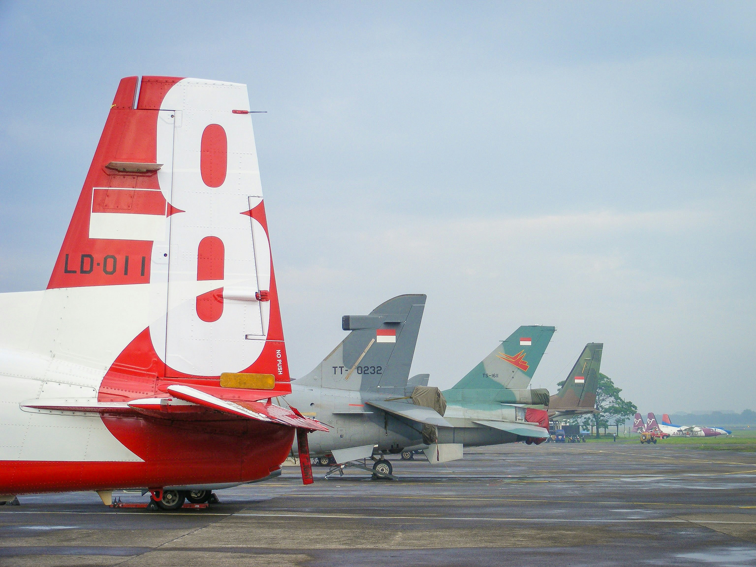 A row of fighter jets sitting on top of an airport tarmac photo – Free ...