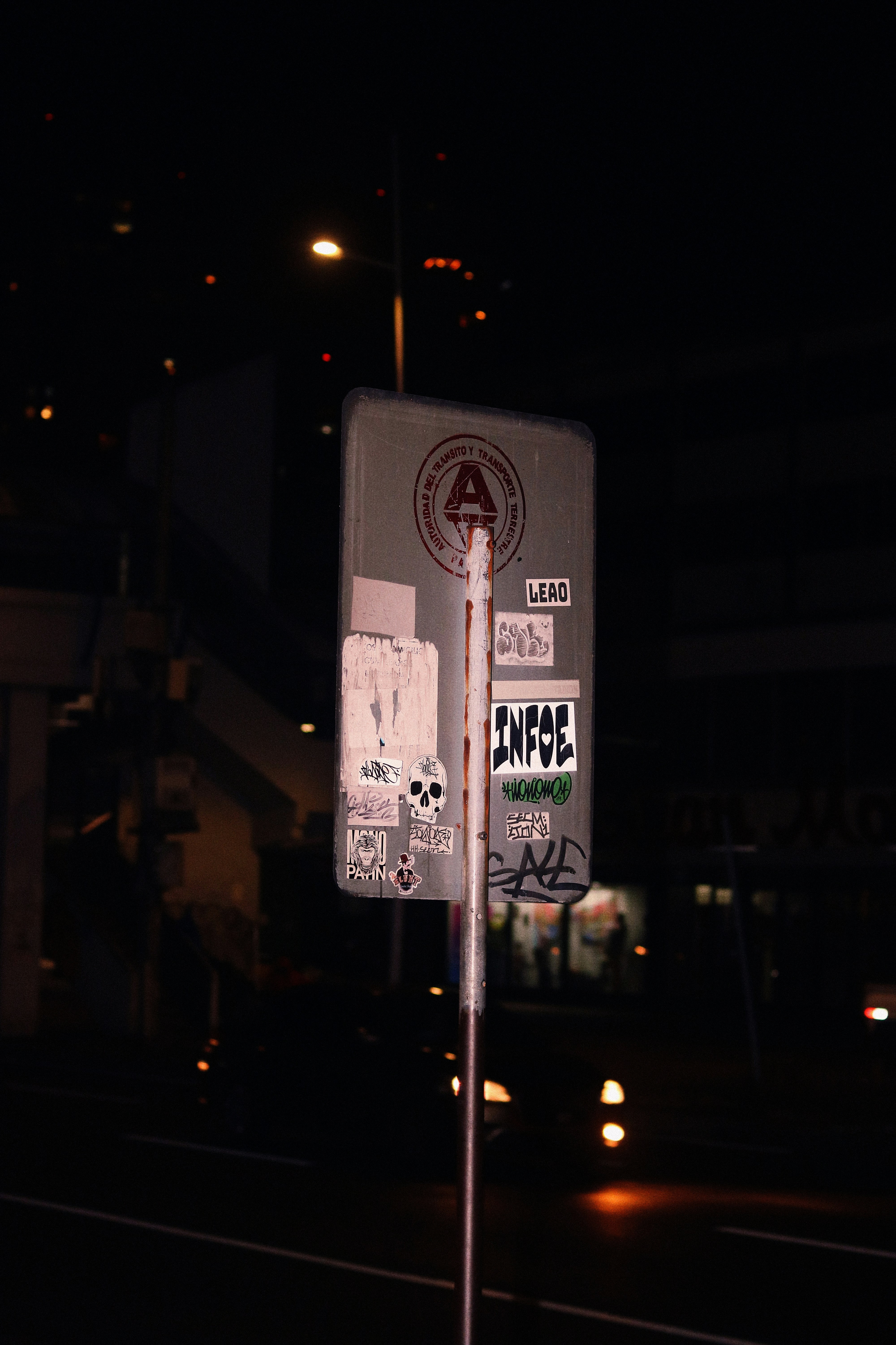 A street sign with stickers on it at night photo – Free Panama city ...