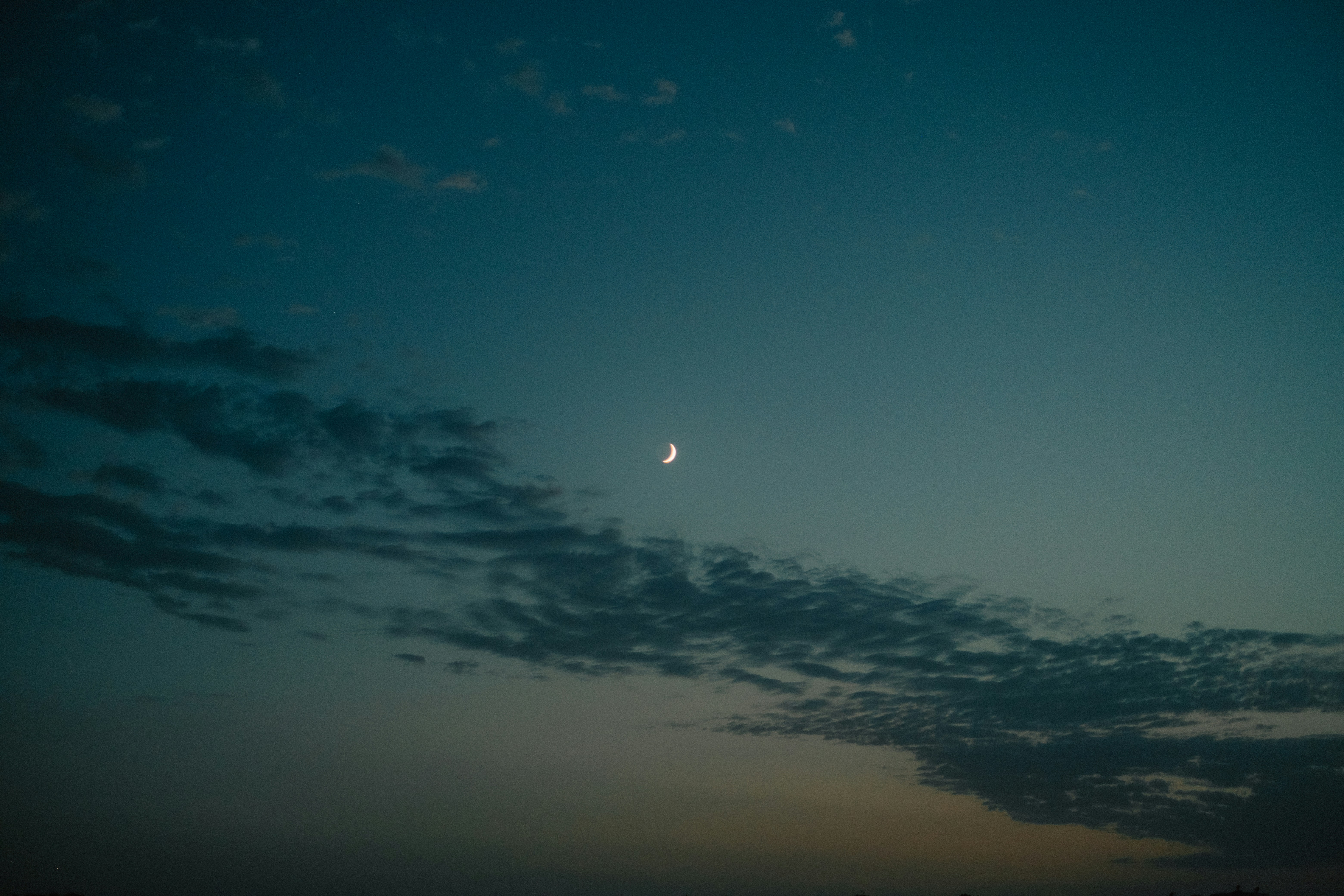 Lunar Glow Amidst Twilight CloudsFelix Bacher