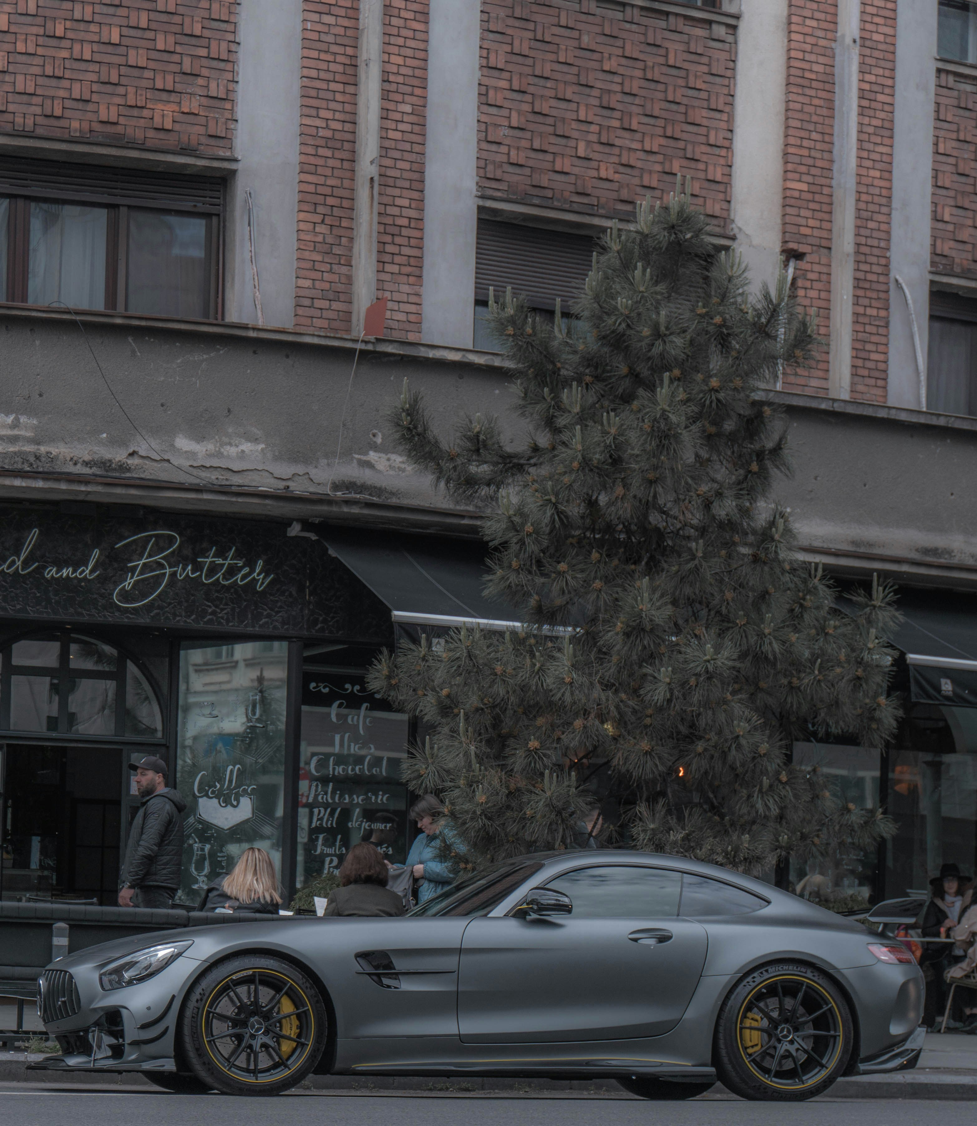 Urban Elegance: Silver Sports Car at the Café