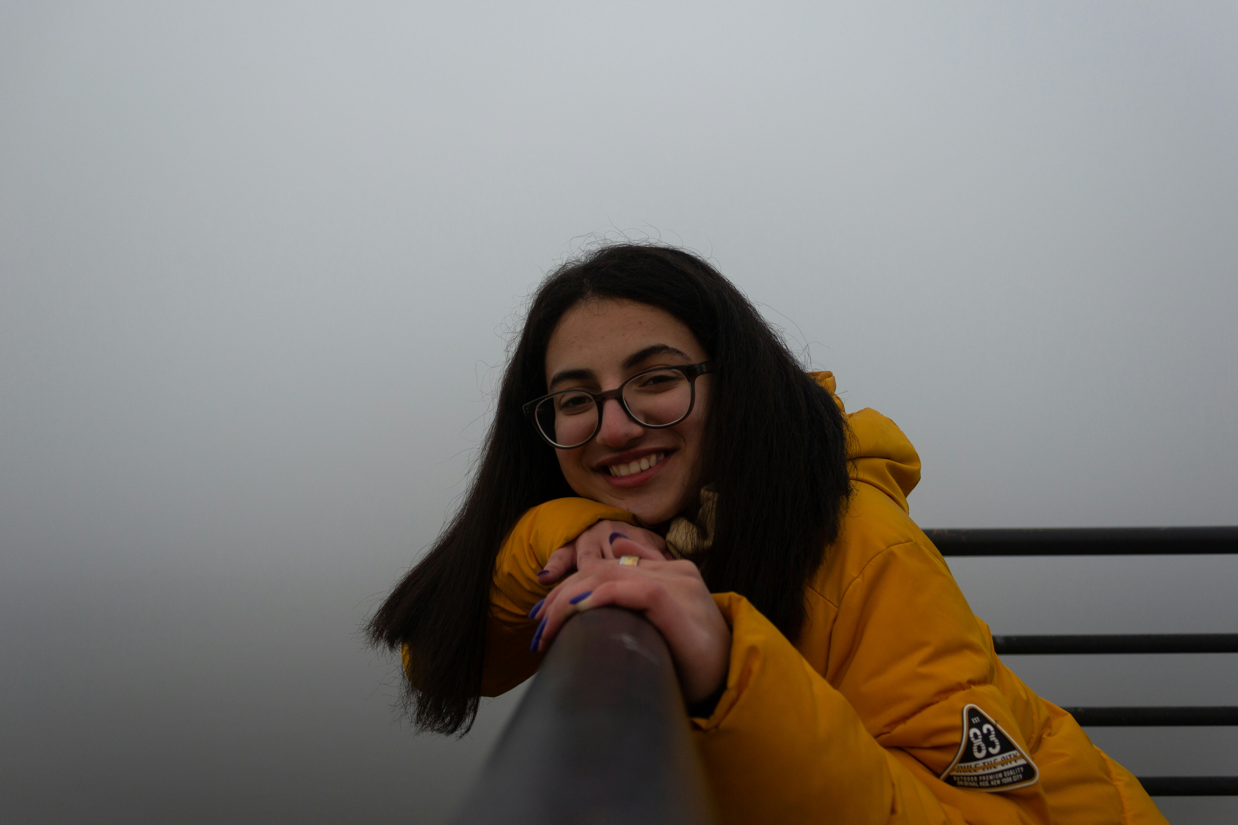 Fog on the Pier: Portrait of a Girl in a Bright Yellow Jacket