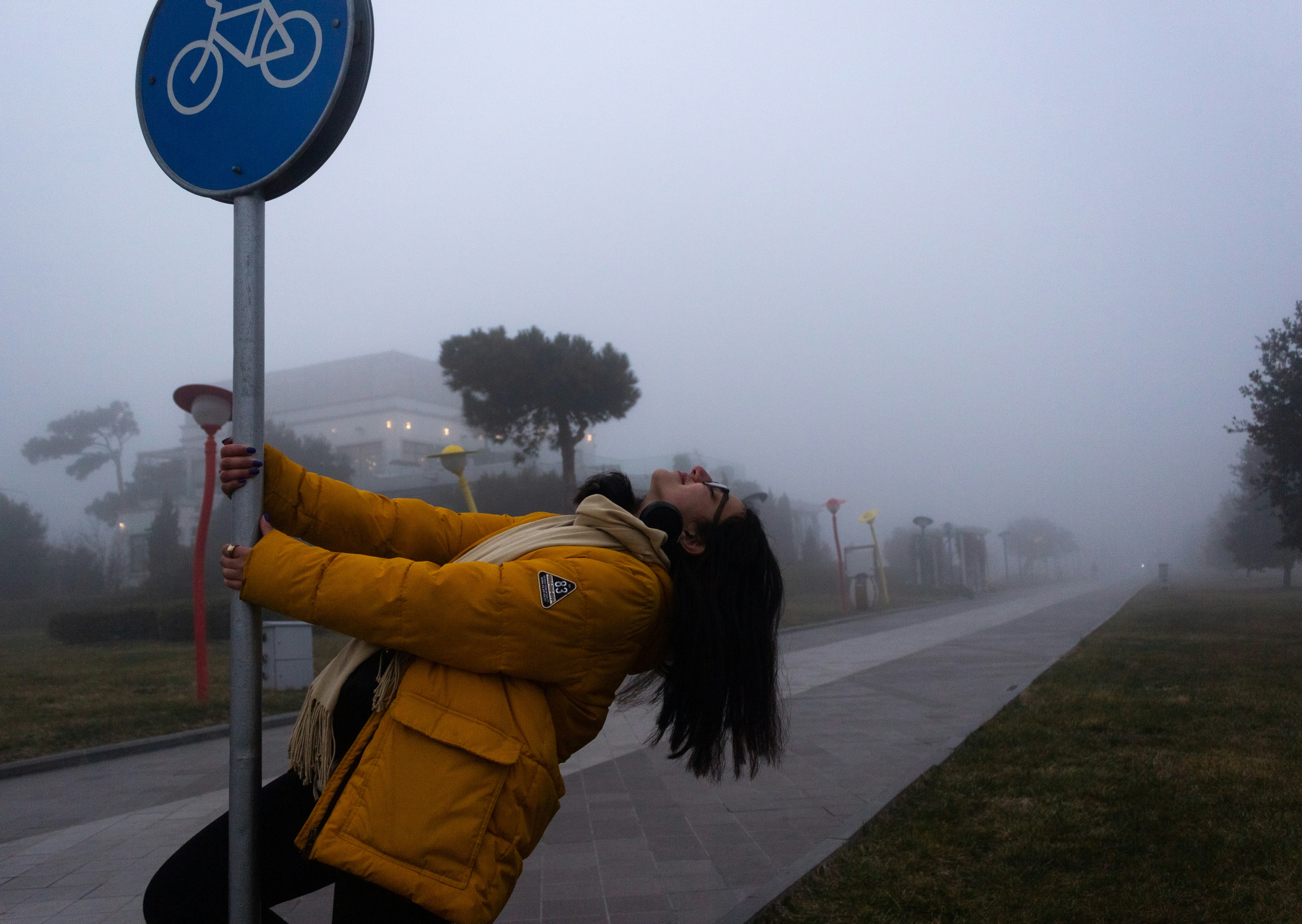 Leaned into the Fog: Portrait at the Bicycle Sign