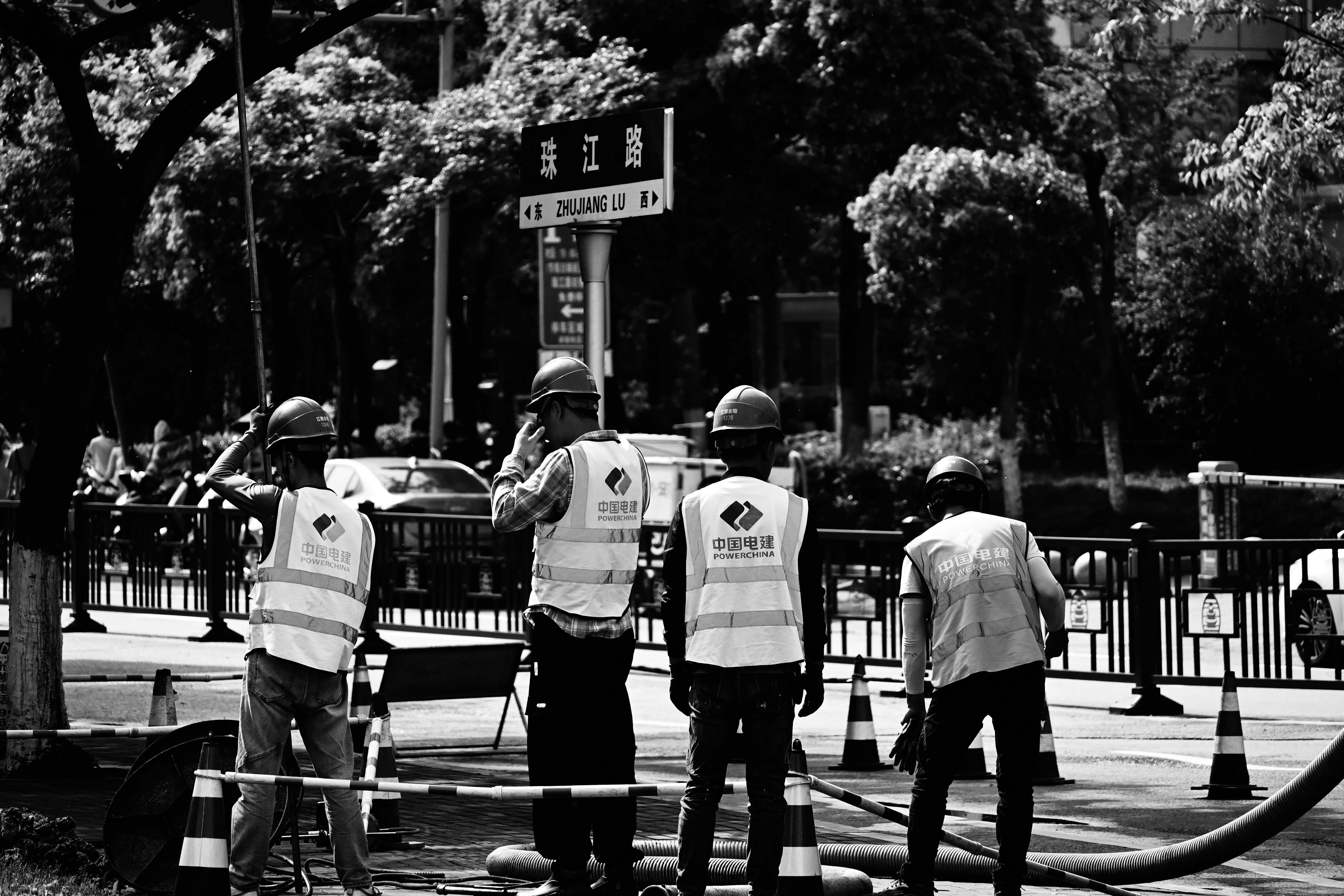 A group of men standing around a fire hydrant photo – Free Person Image ...