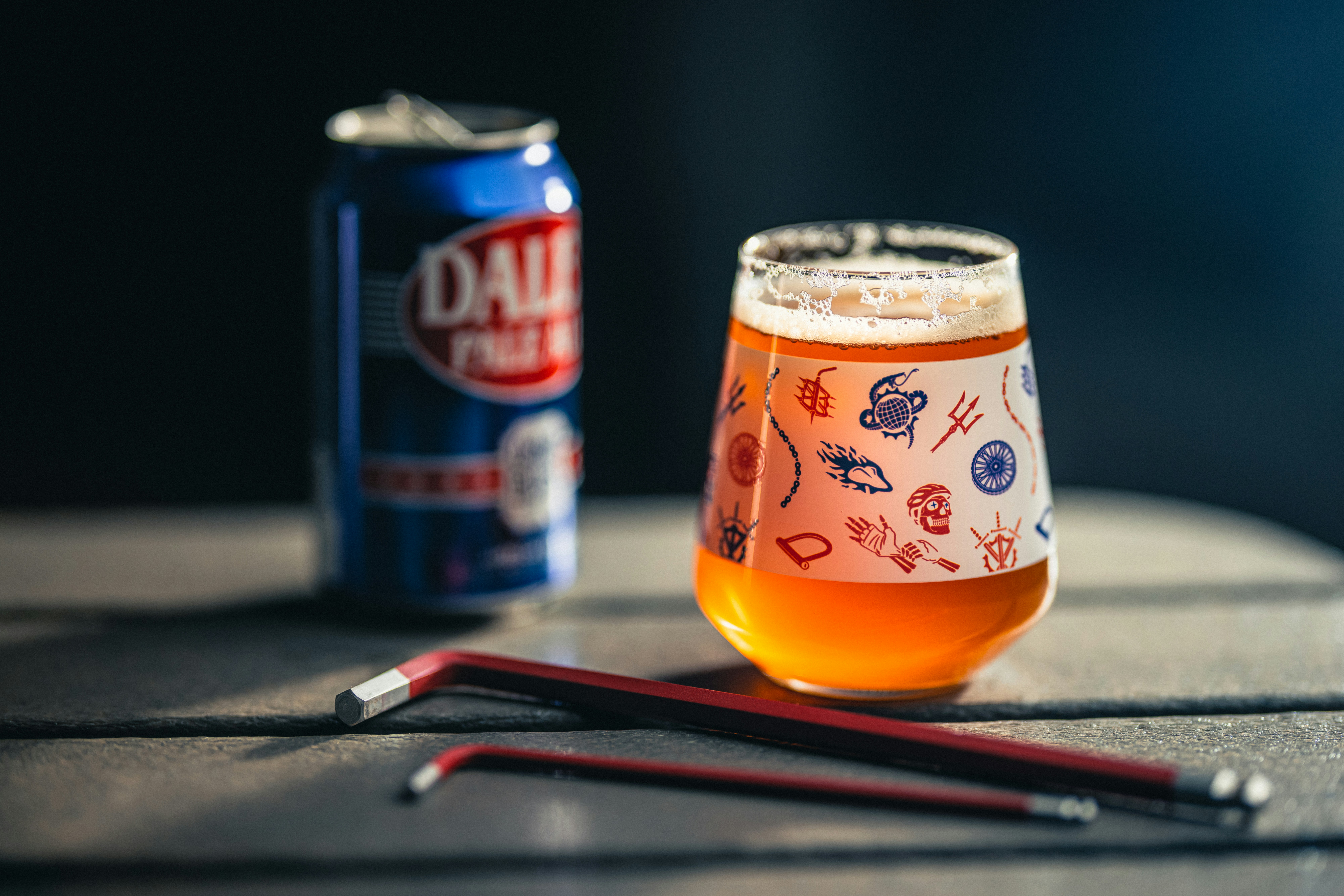 Amber in Focus: Patterned Beer Glass on a Quiet Studio Table
