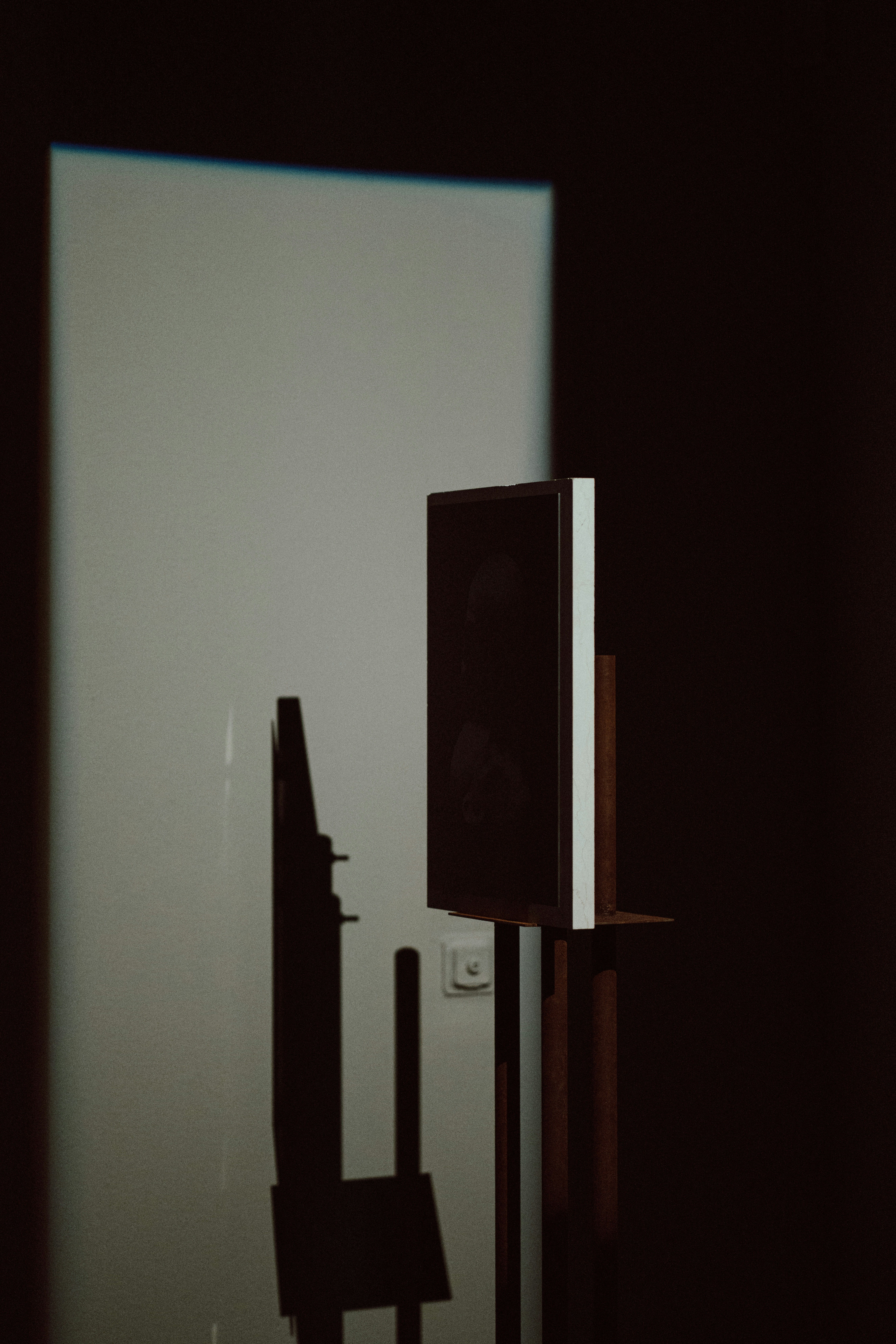The Quiet Speaker: Minimalist Geometry in a Dim Studio