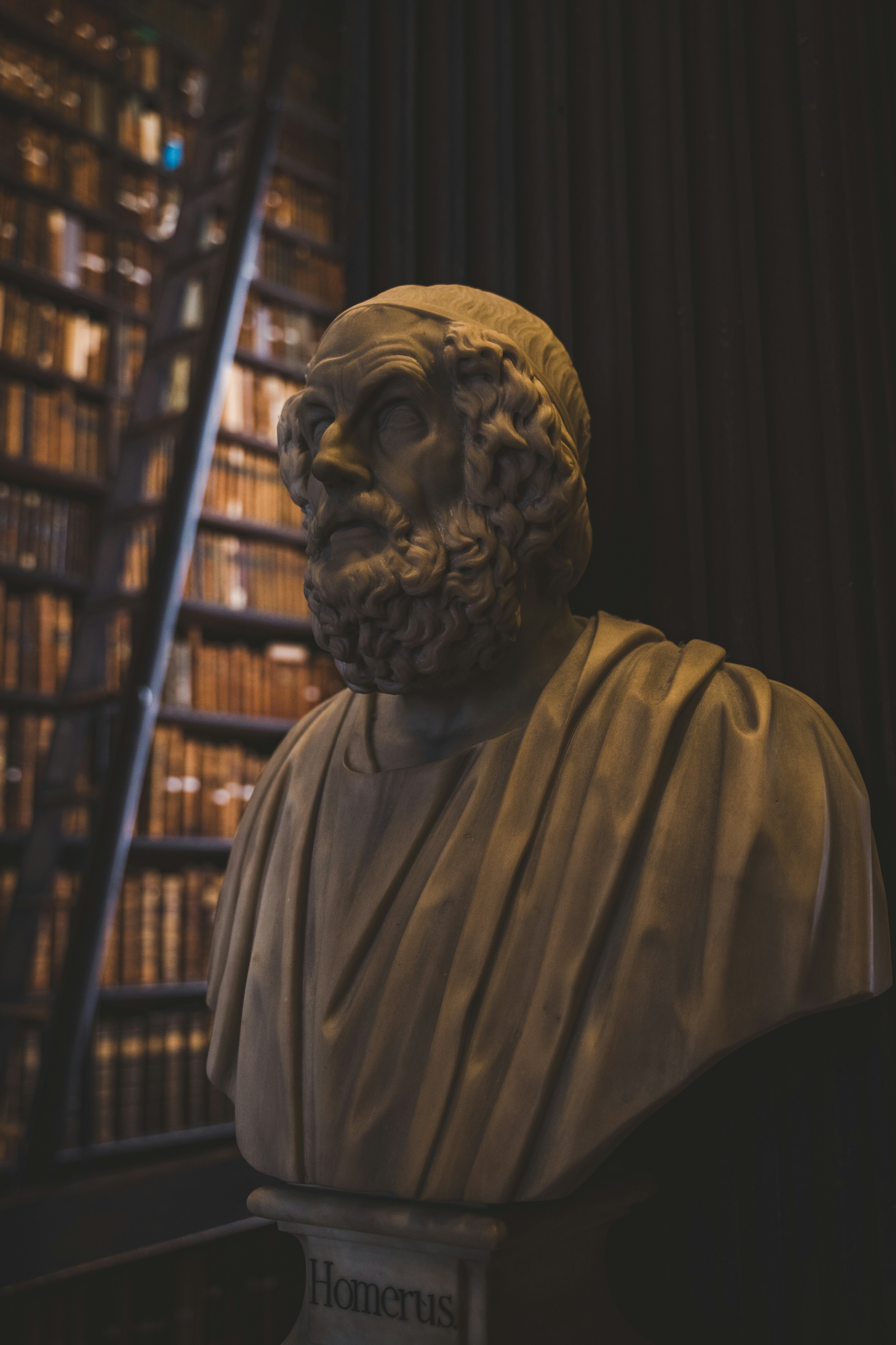Homer Among the Stacks: Marble Portrait Beneath Library Light