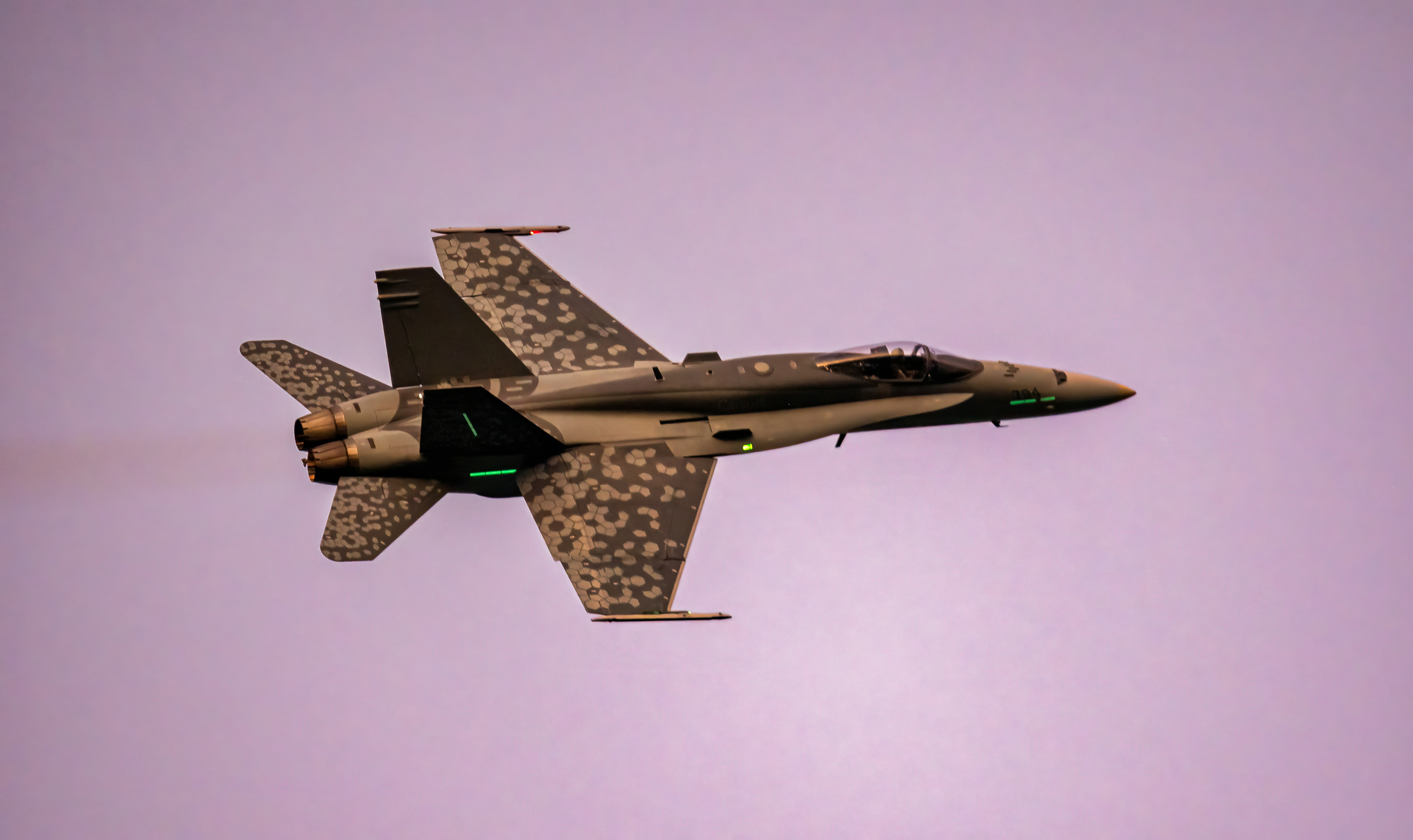 A fighter jet flying through a purple sky photo – Free Airplane Image ...