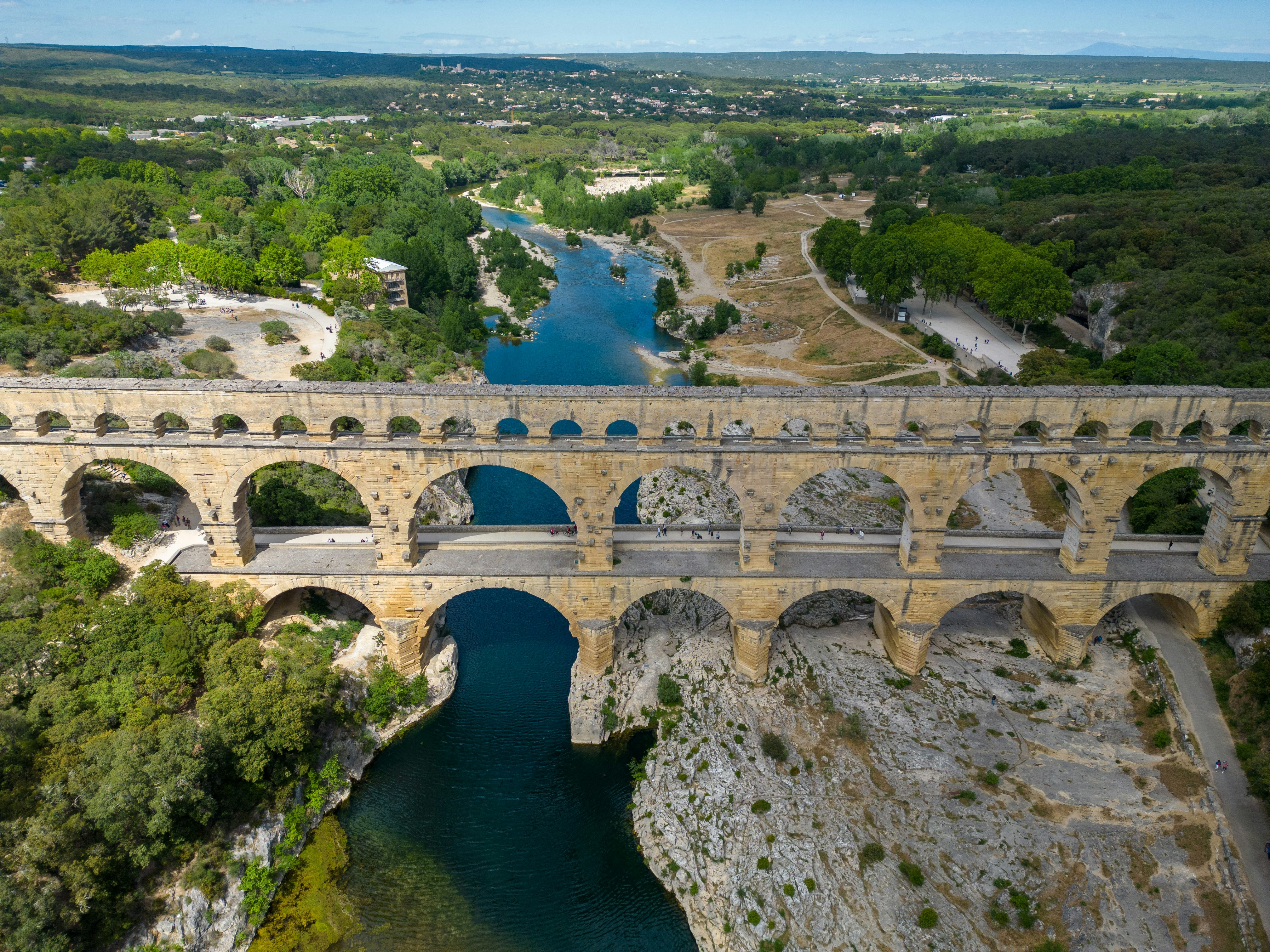 Stone Arches Over a Turquoise River: An Ancient Viaduct in a Lush Gorge