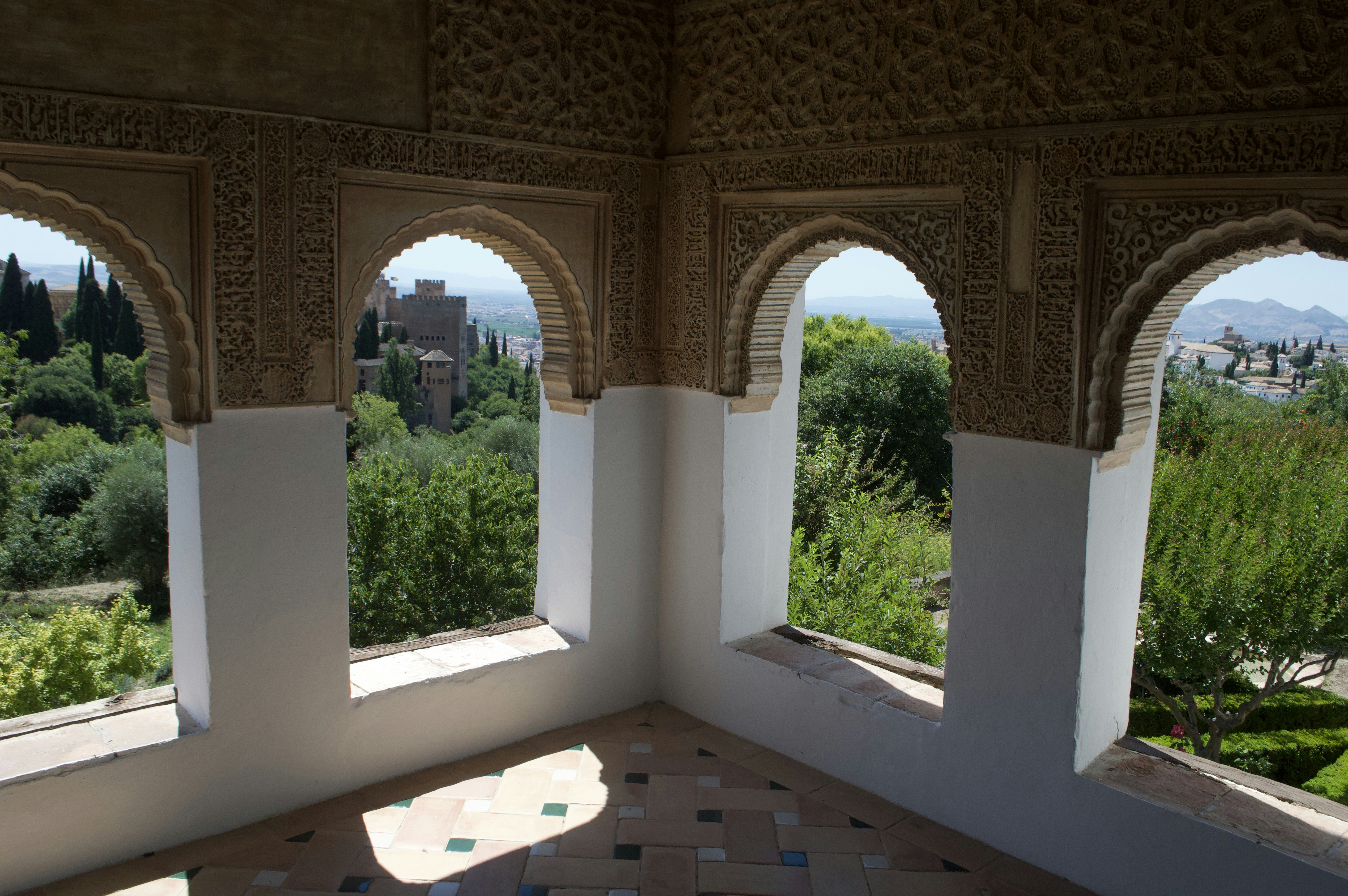 Sunlit Courtyard Arches Framing a Verdant Panorama