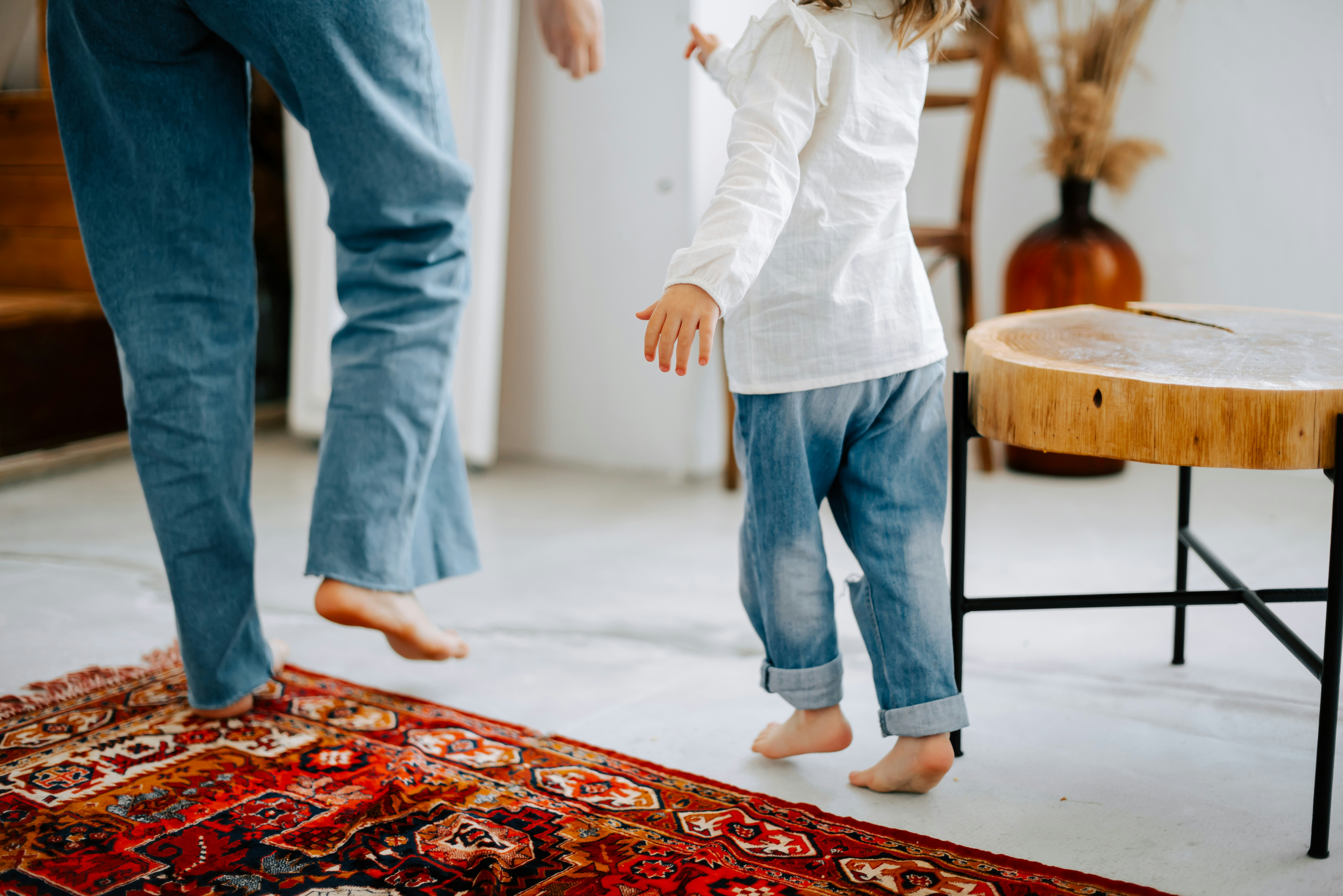 Footsteps in a Bright Living Room: A Mini Dance Between a Parent and Child