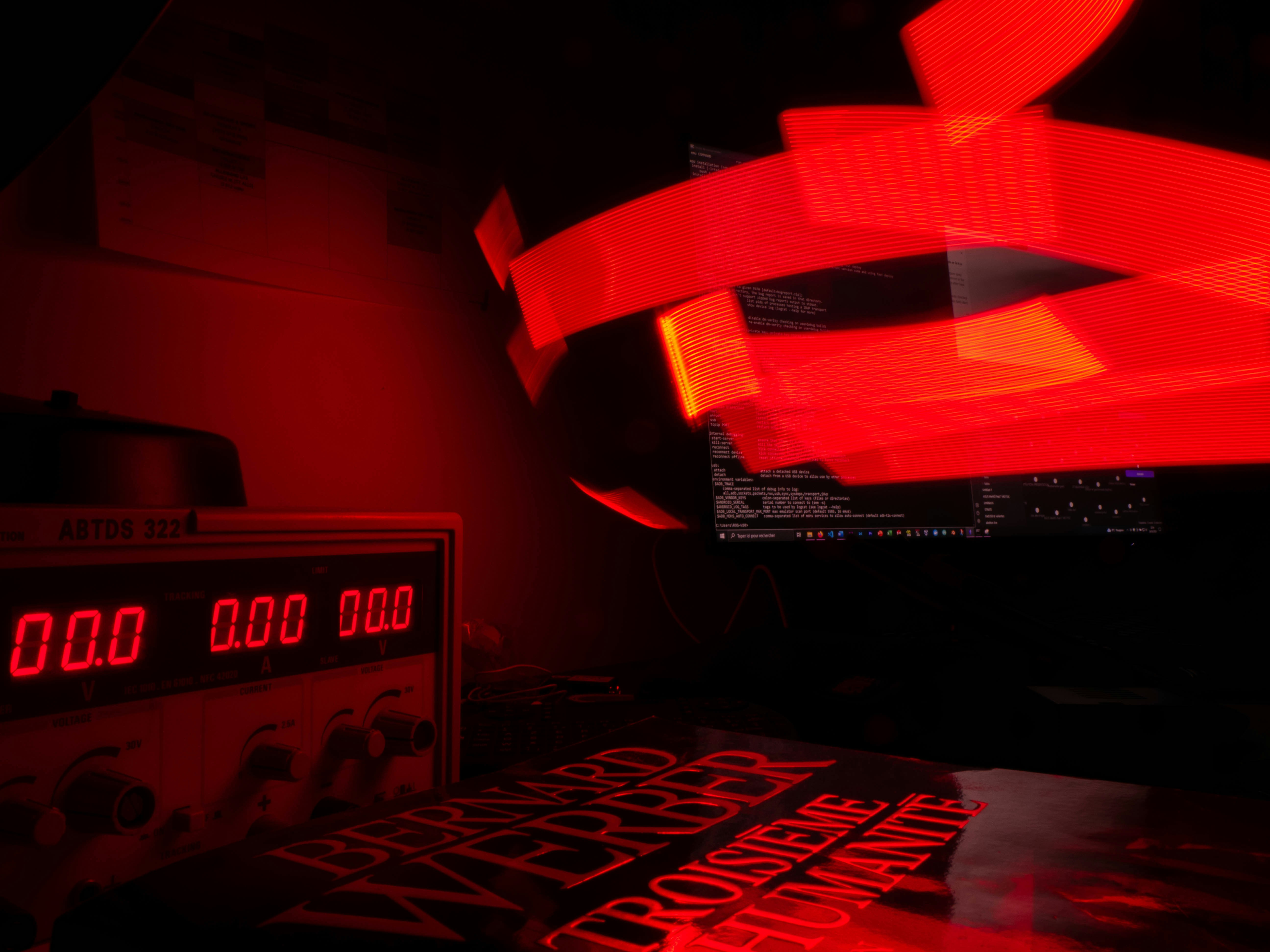 Crimson Ribbons Over a Quiet Tech Desk