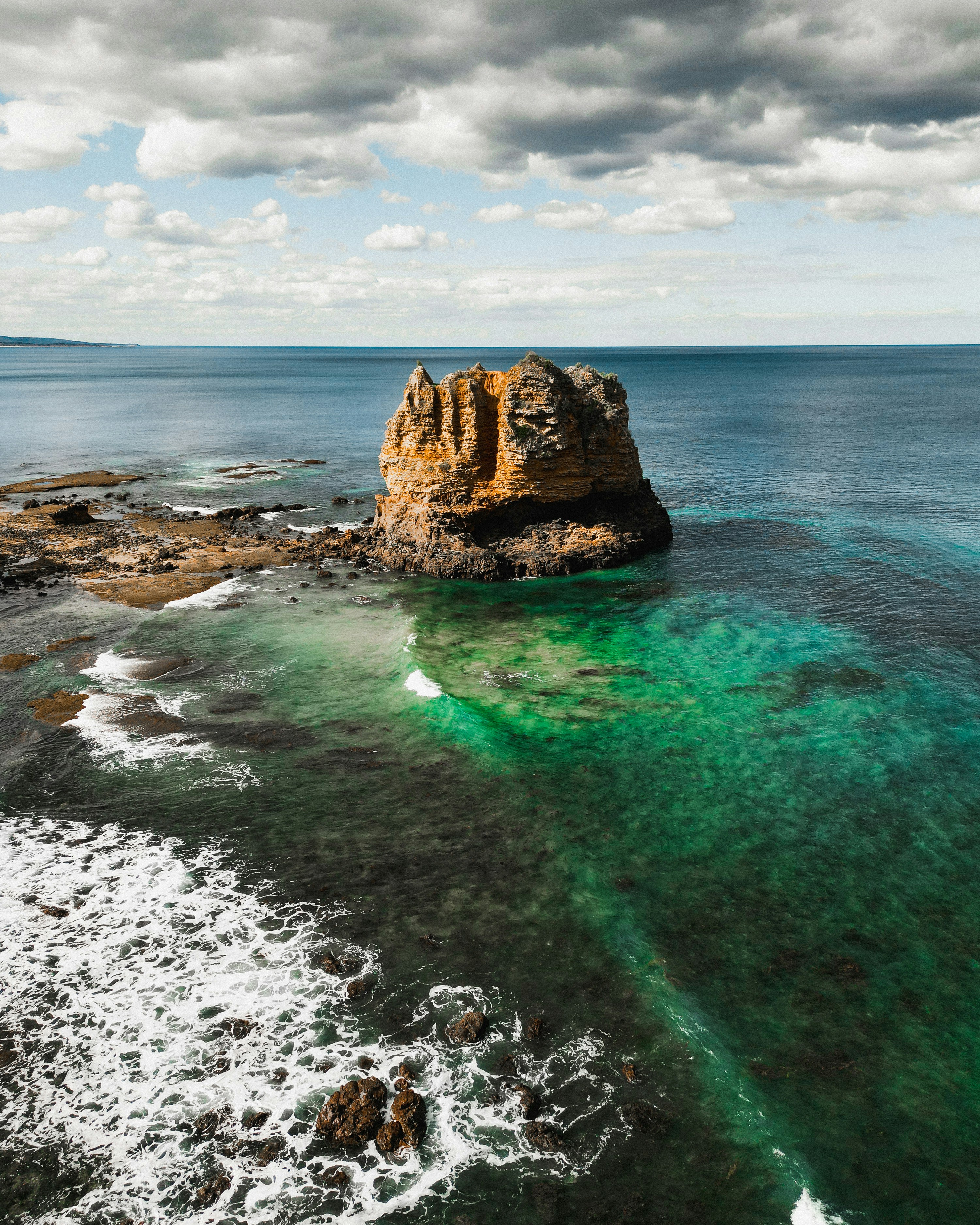 A large rock sticking out of the ocean photo – Free Nature Image on ...